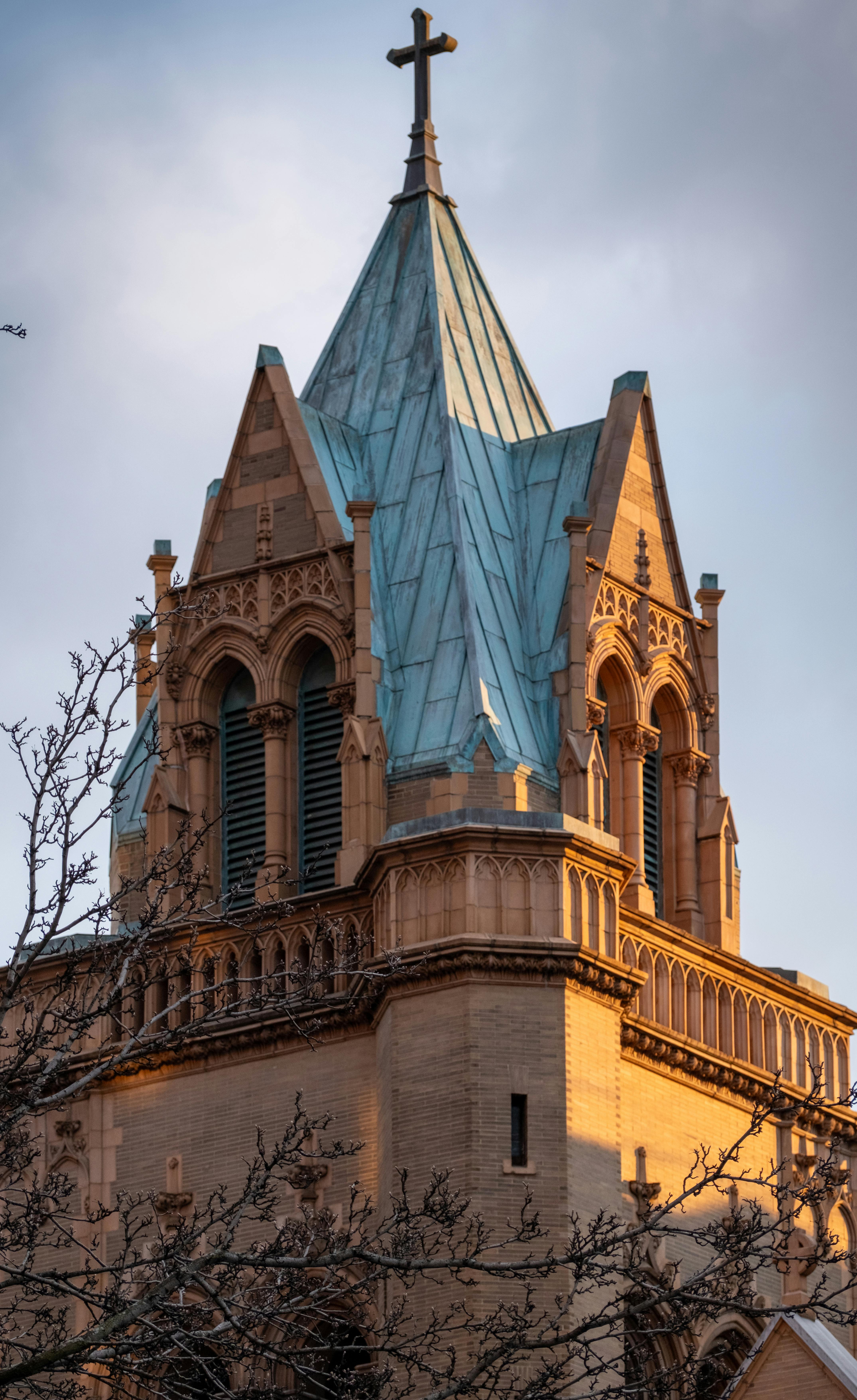 Gothic Church Spire with Copper Roof at Sunset · Free Stock Photo