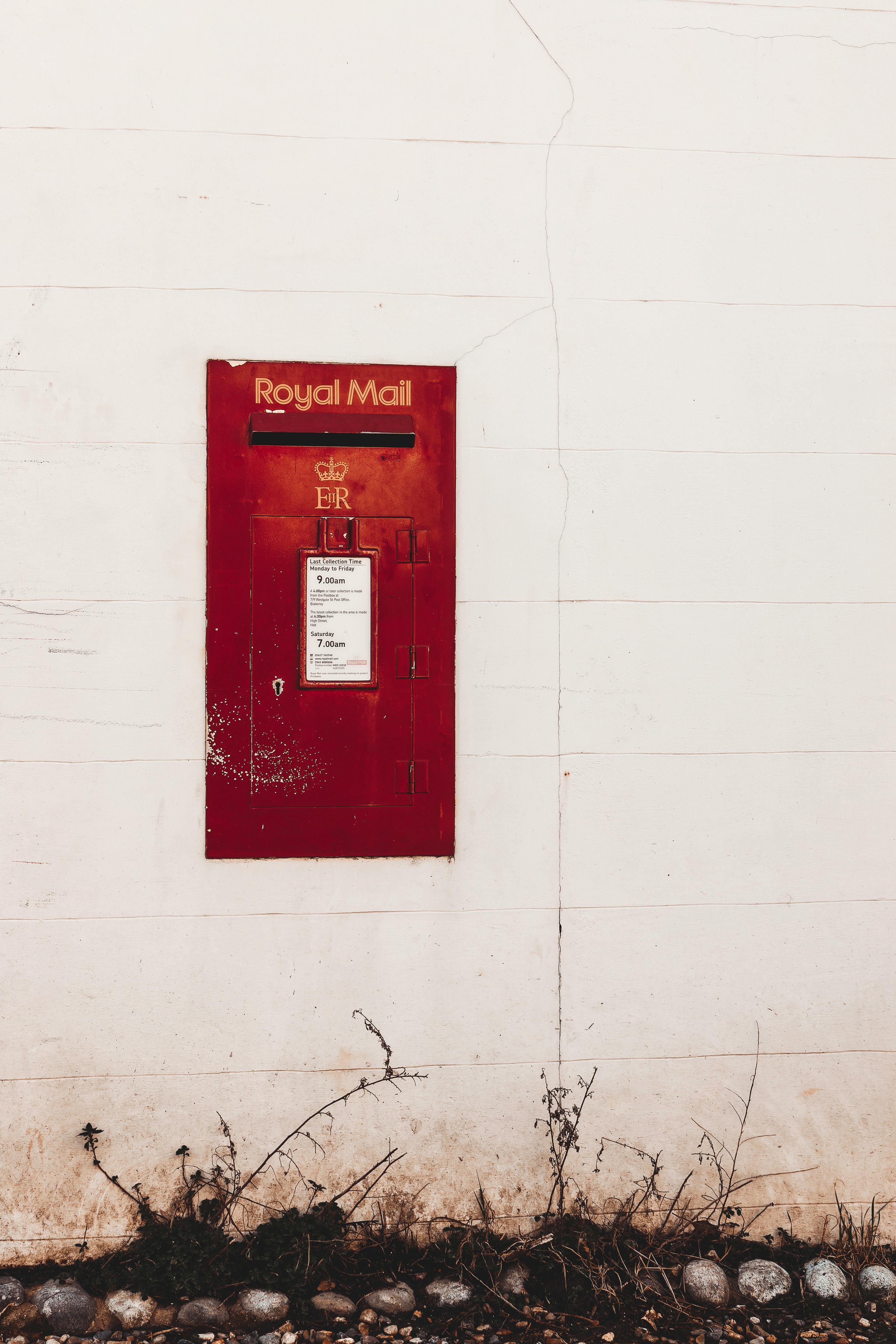 Traditional Red British Post Box on White Wall · Free Stock Photo
