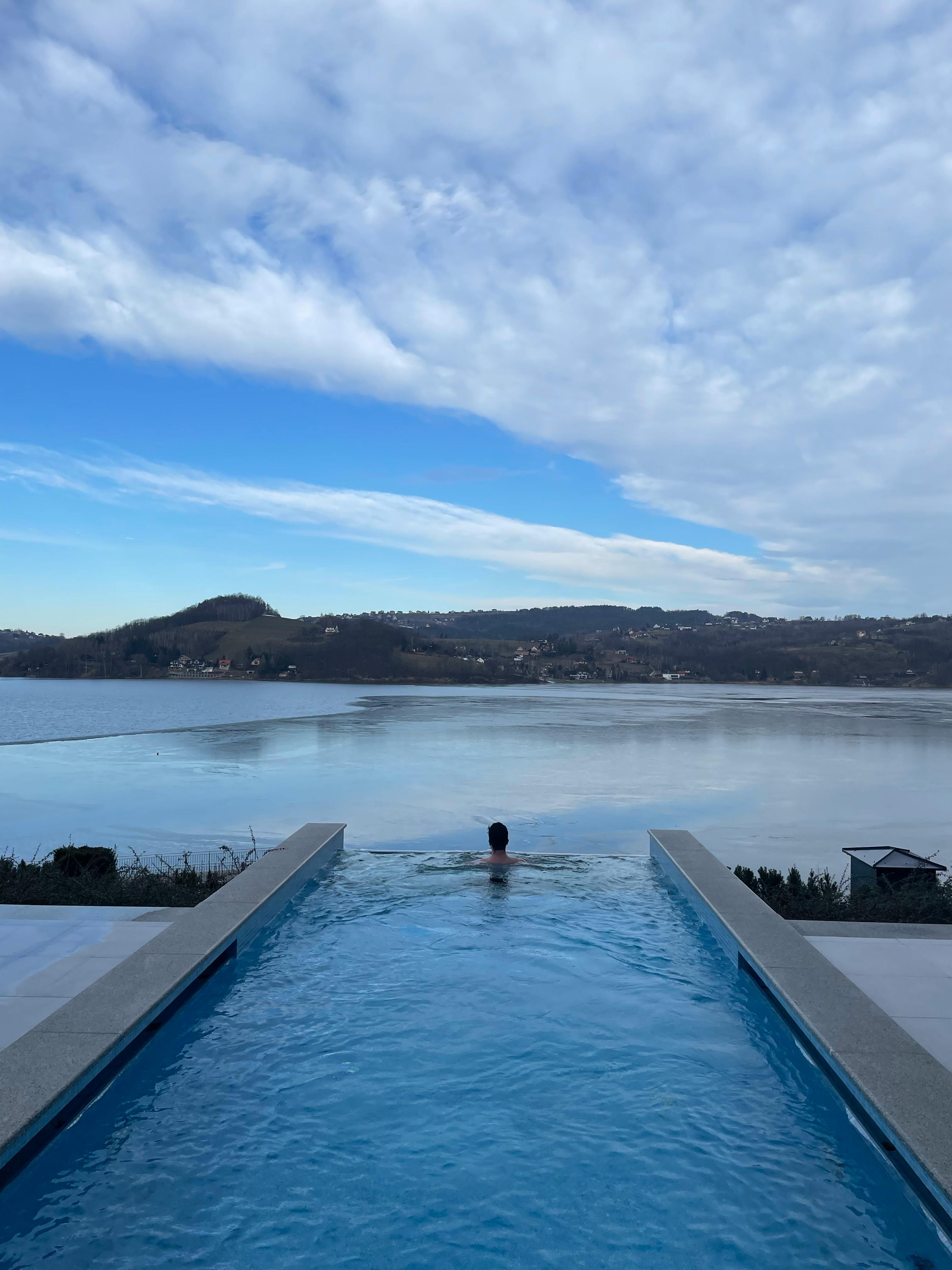 Serene Infinity Pool Overlooking Lake Sienna · Free Stock Photo