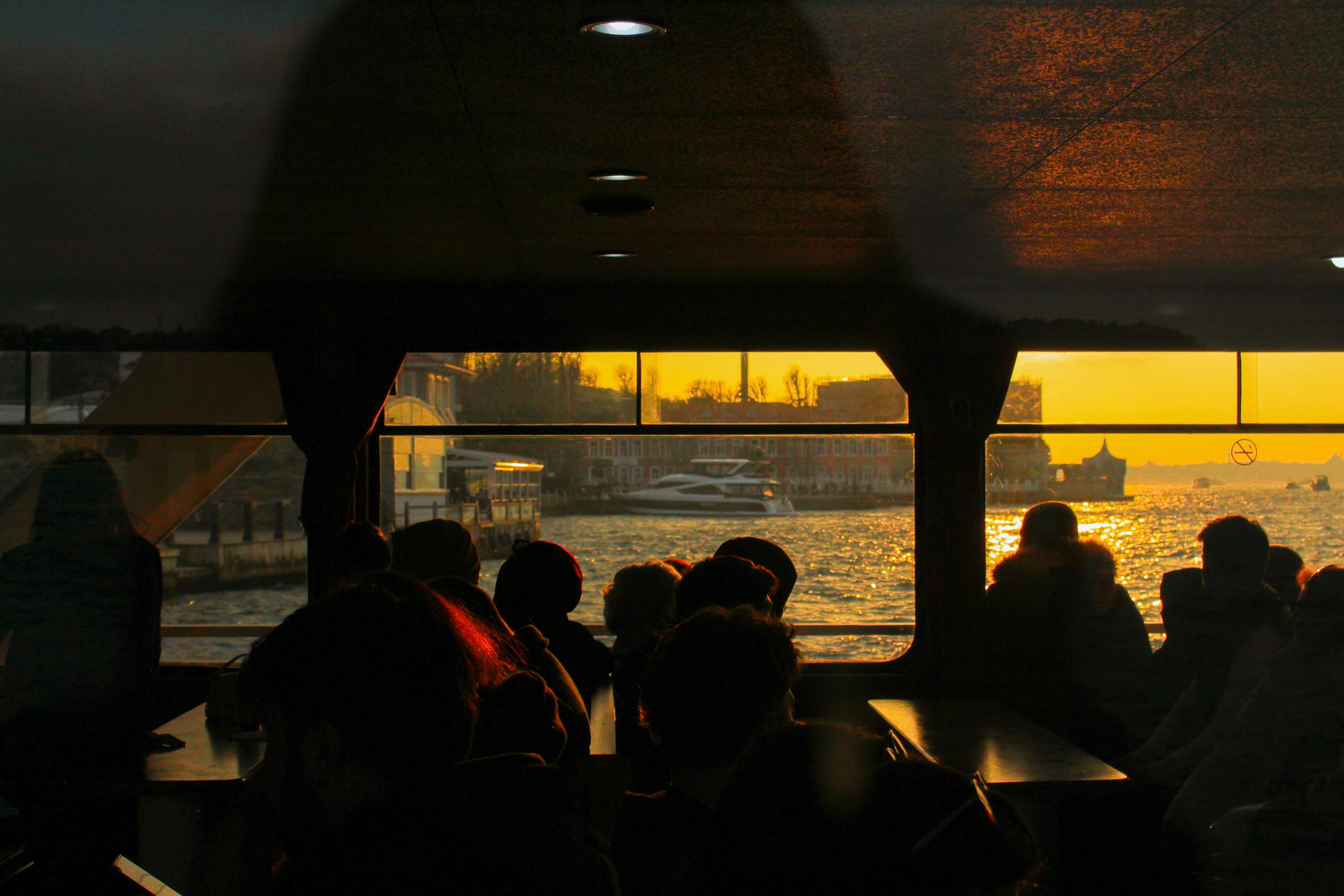 Silhouette of Passengers on Ferry at Sunset · Free Stock Photo