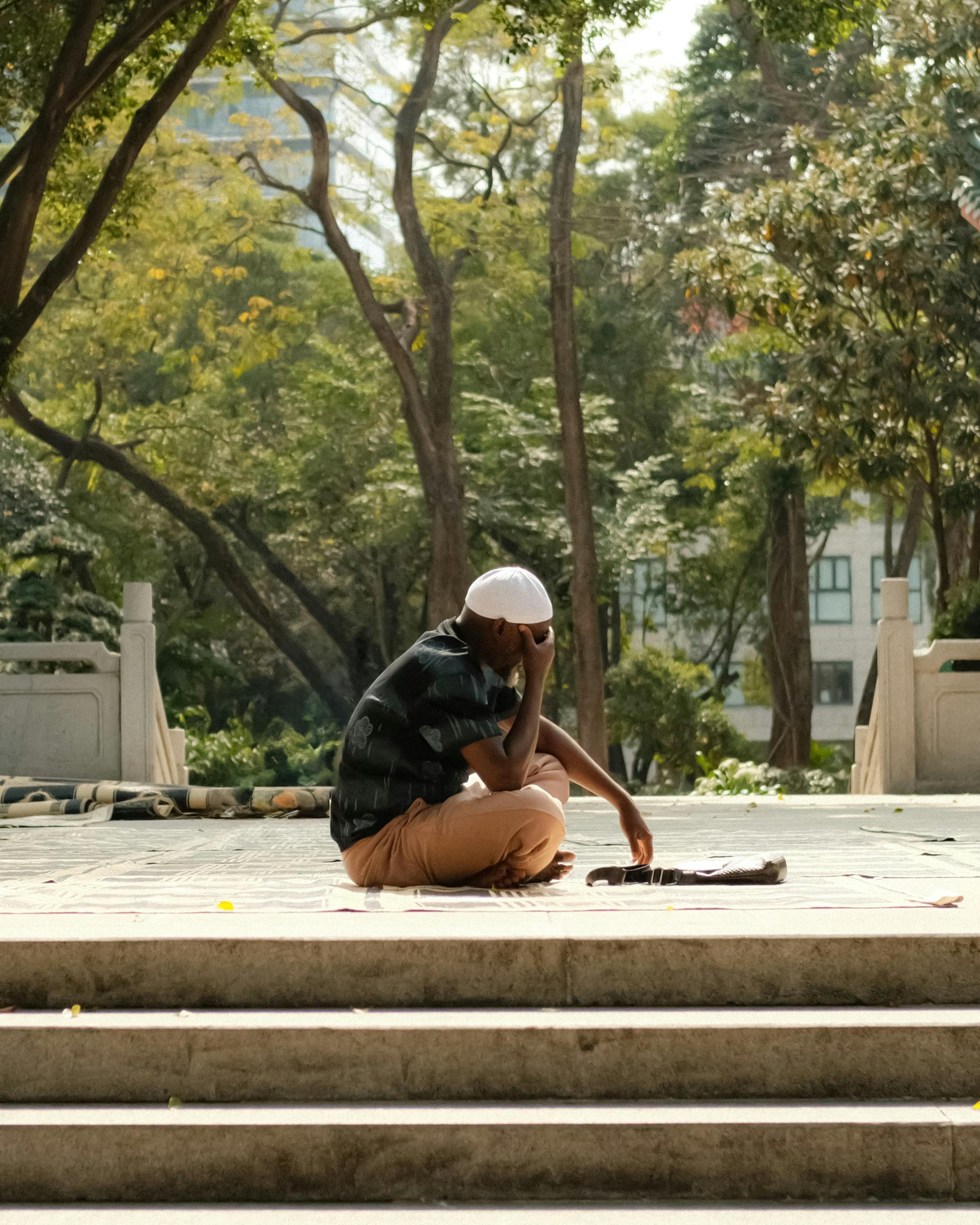 Man Praying Outdoors in Peaceful Park Setting · Free Stock Photo