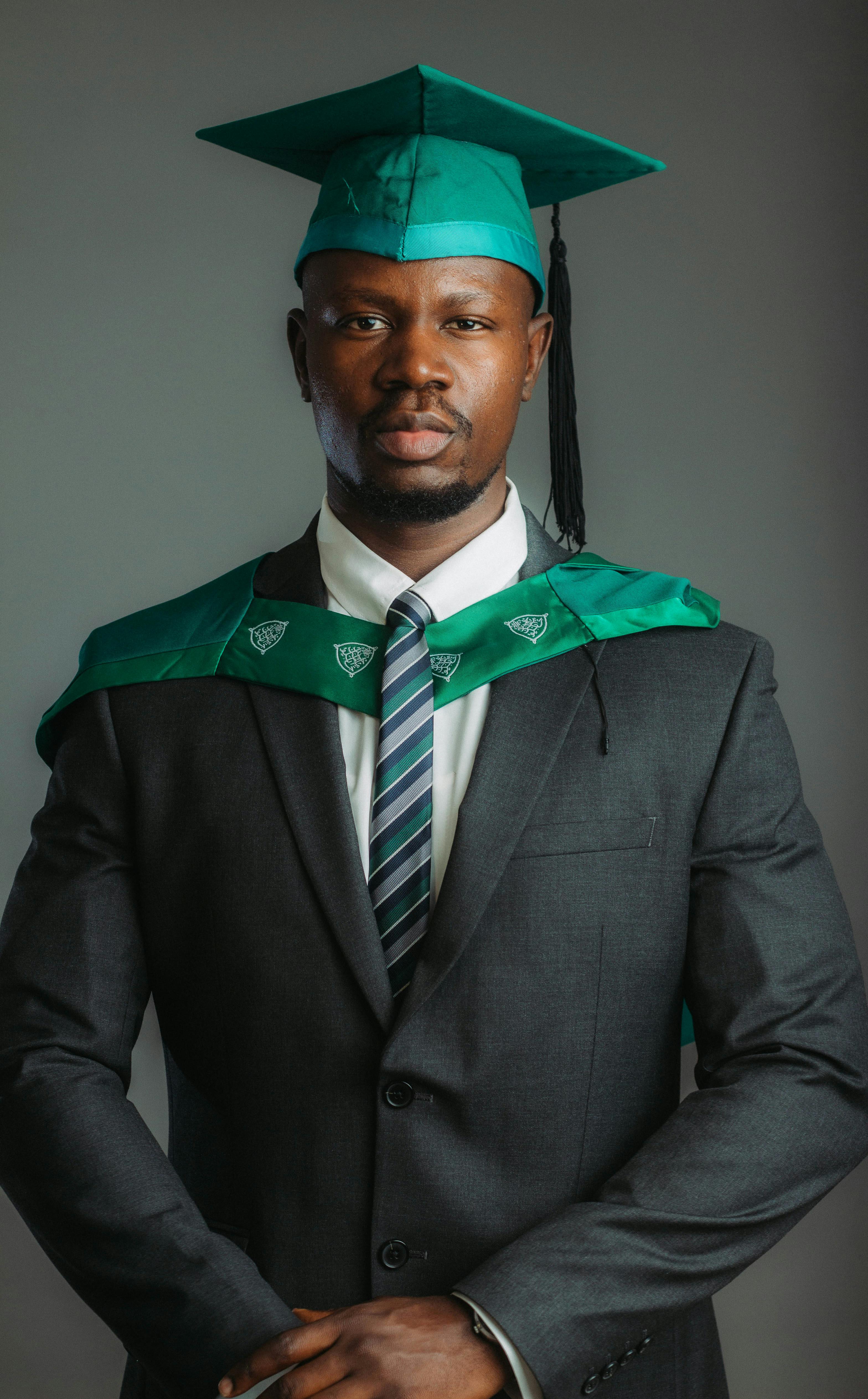 Proud Graduate in Cap and Gown · Free Stock Photo