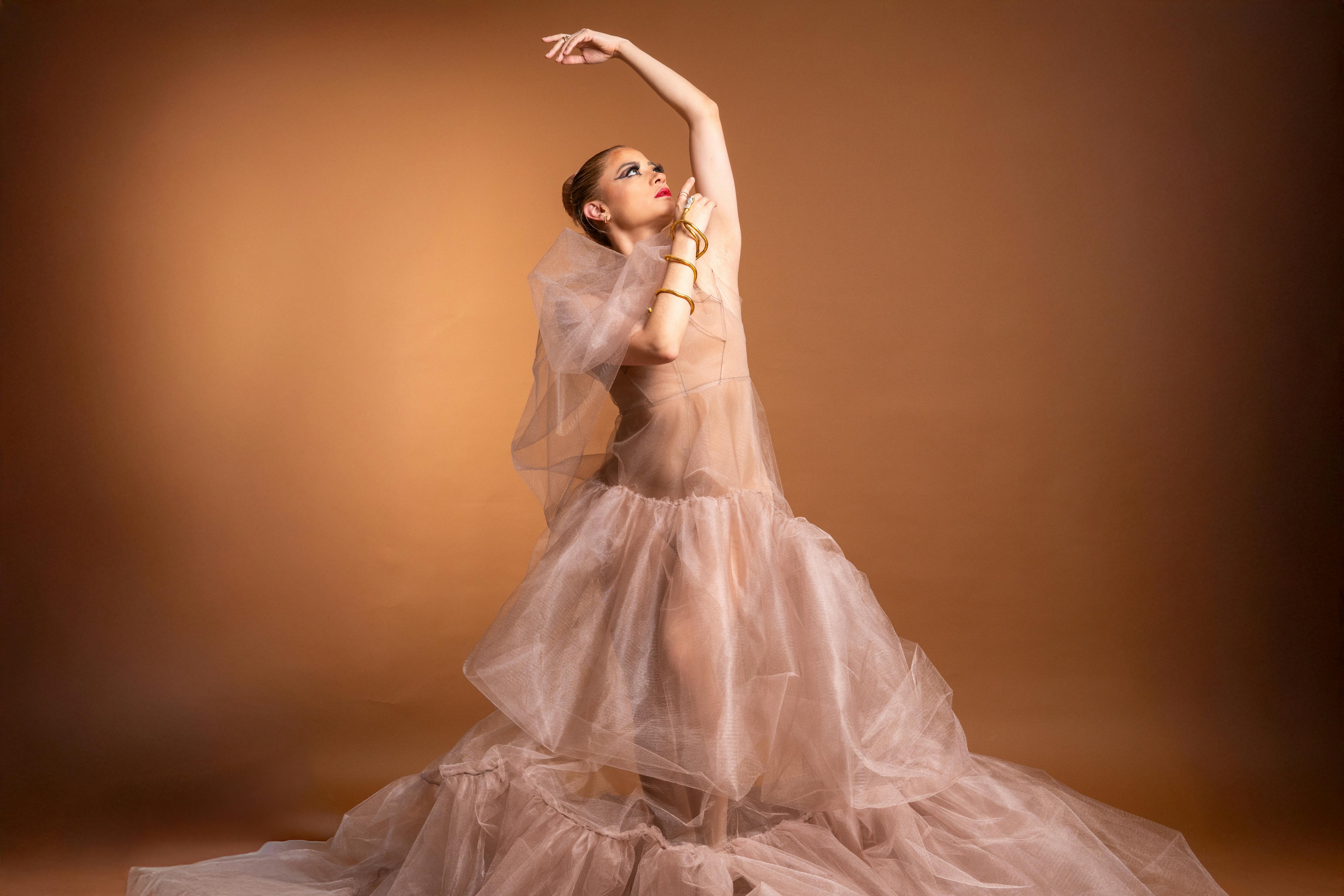 Elegant Ballerina in Flowing Mocha Dress · Free Stock Photo