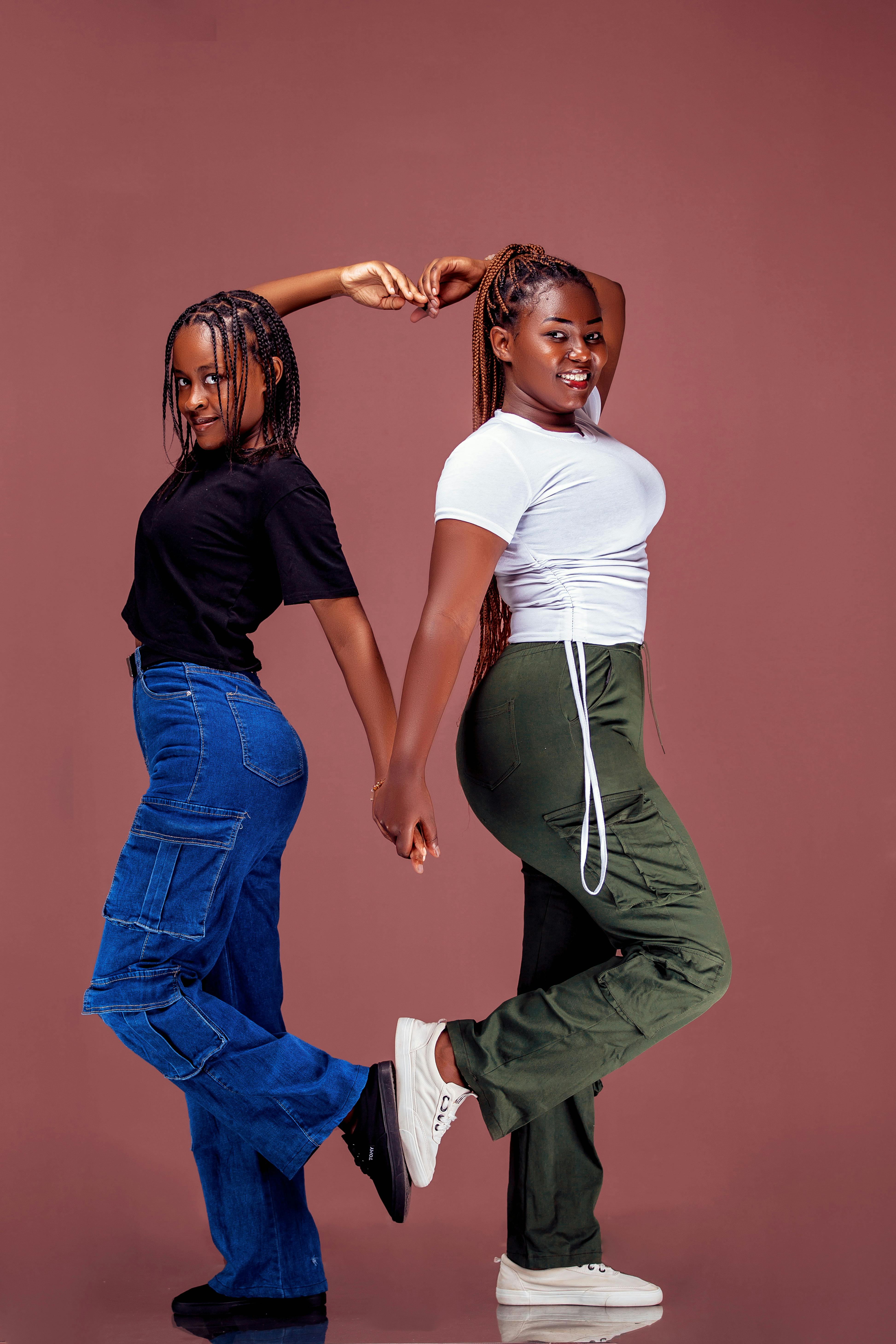 Two young women posing fashionably indoors · Free Stock Photo