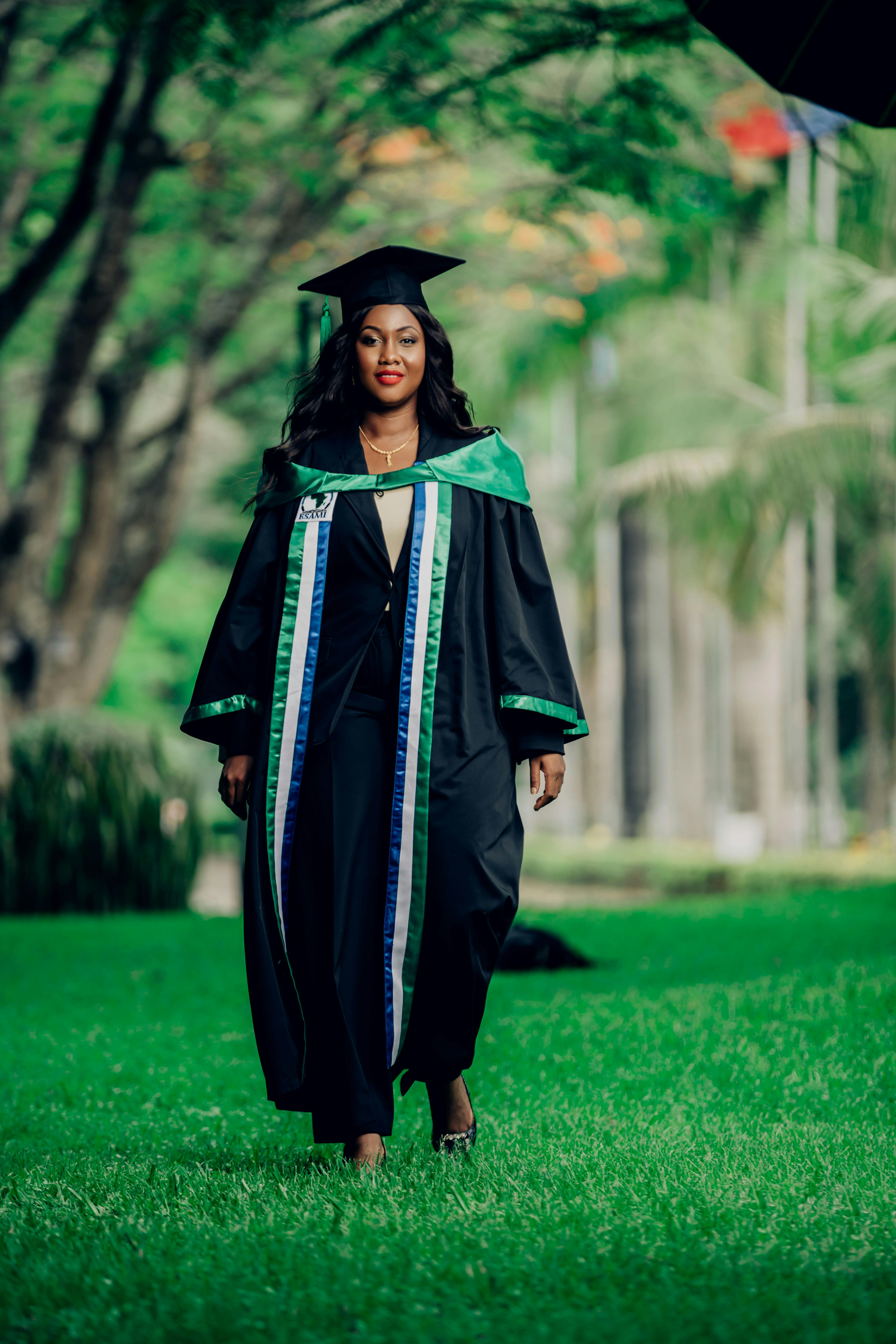 Happy Graduate Walking in Green Park Setting · Free Stock Photo