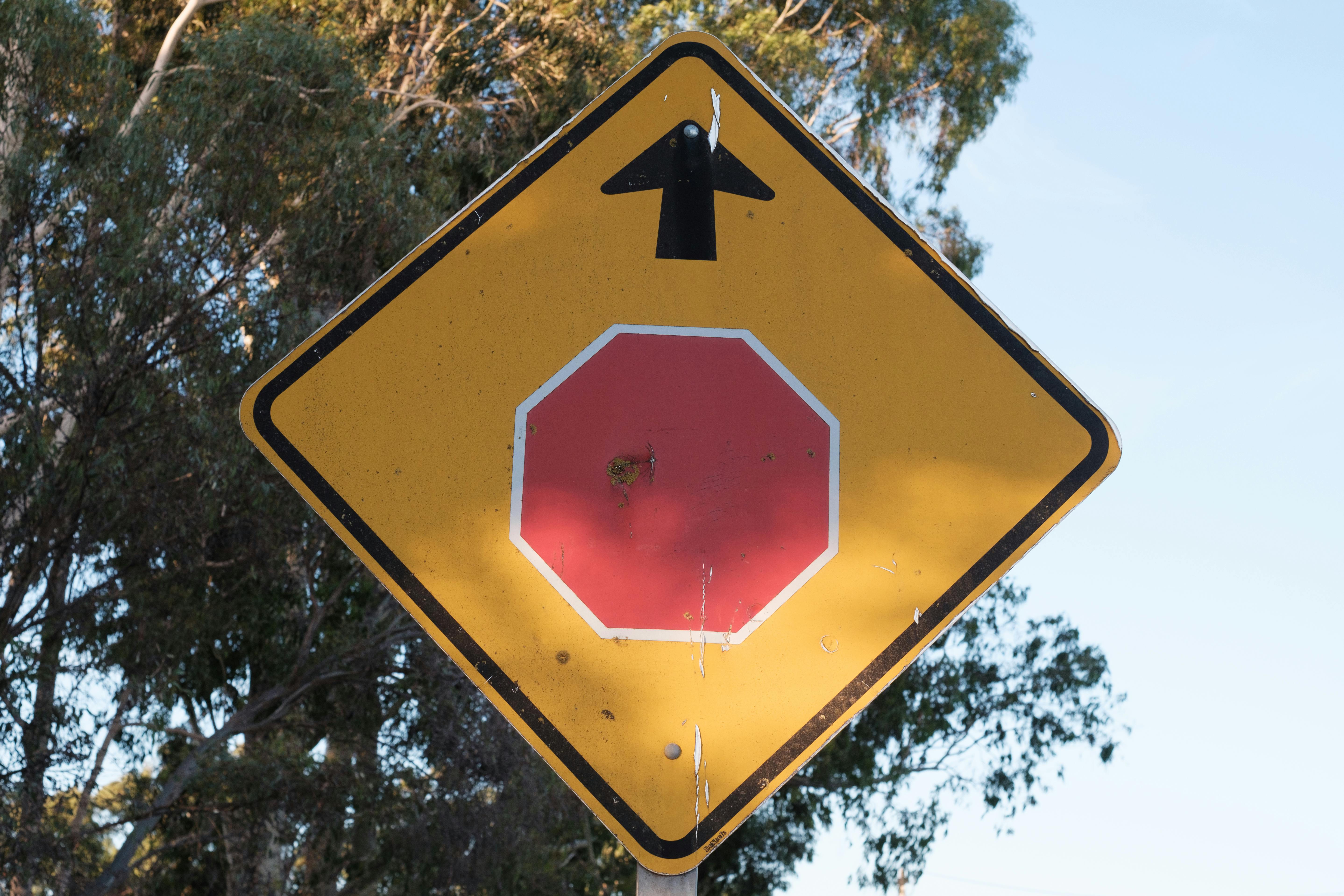 Traffic Sign with Arrow and Octagon Warning · Free Stock Photo