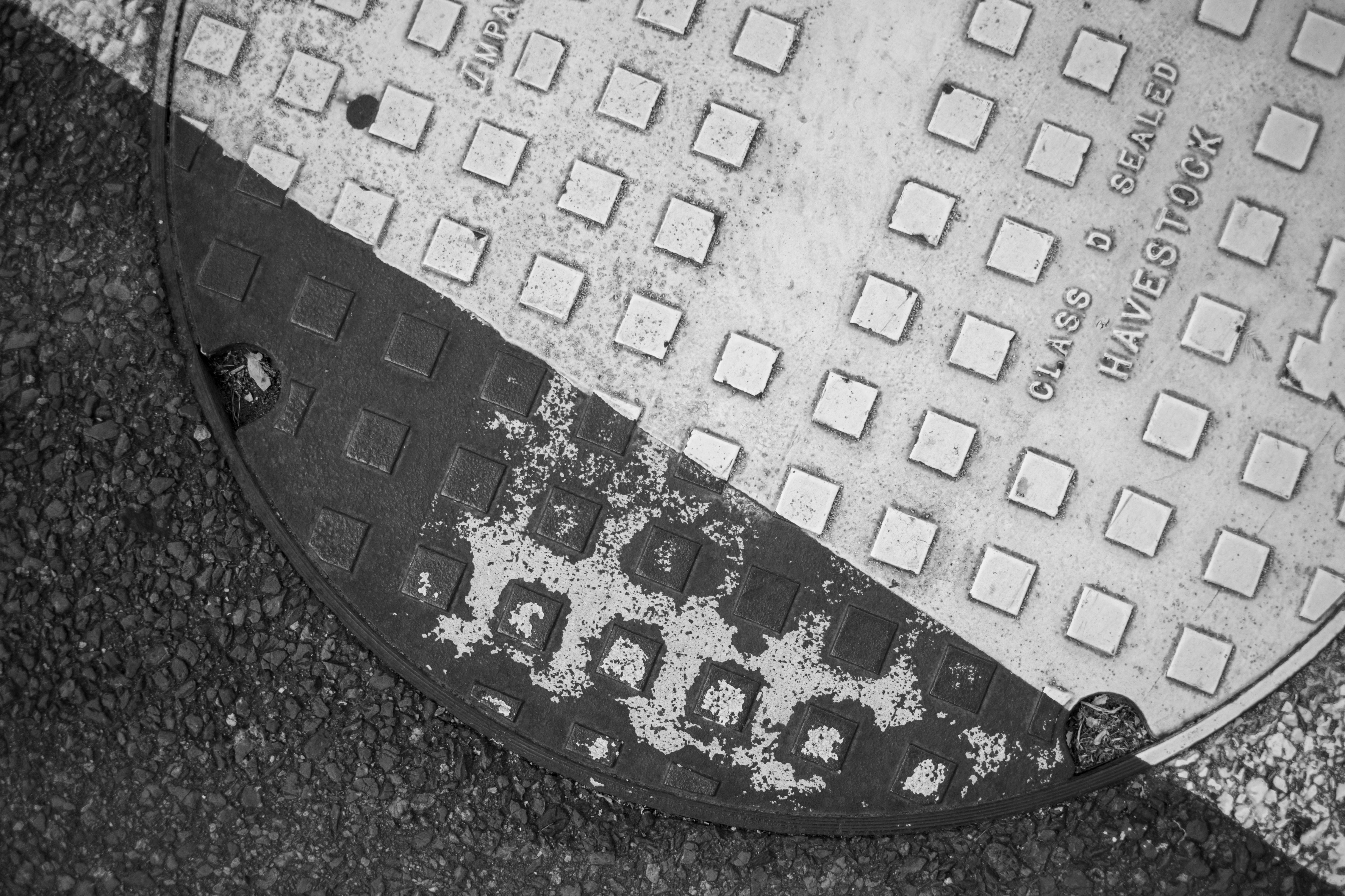 Abstract geometric pattern on manhole cover · Free Stock Photo
