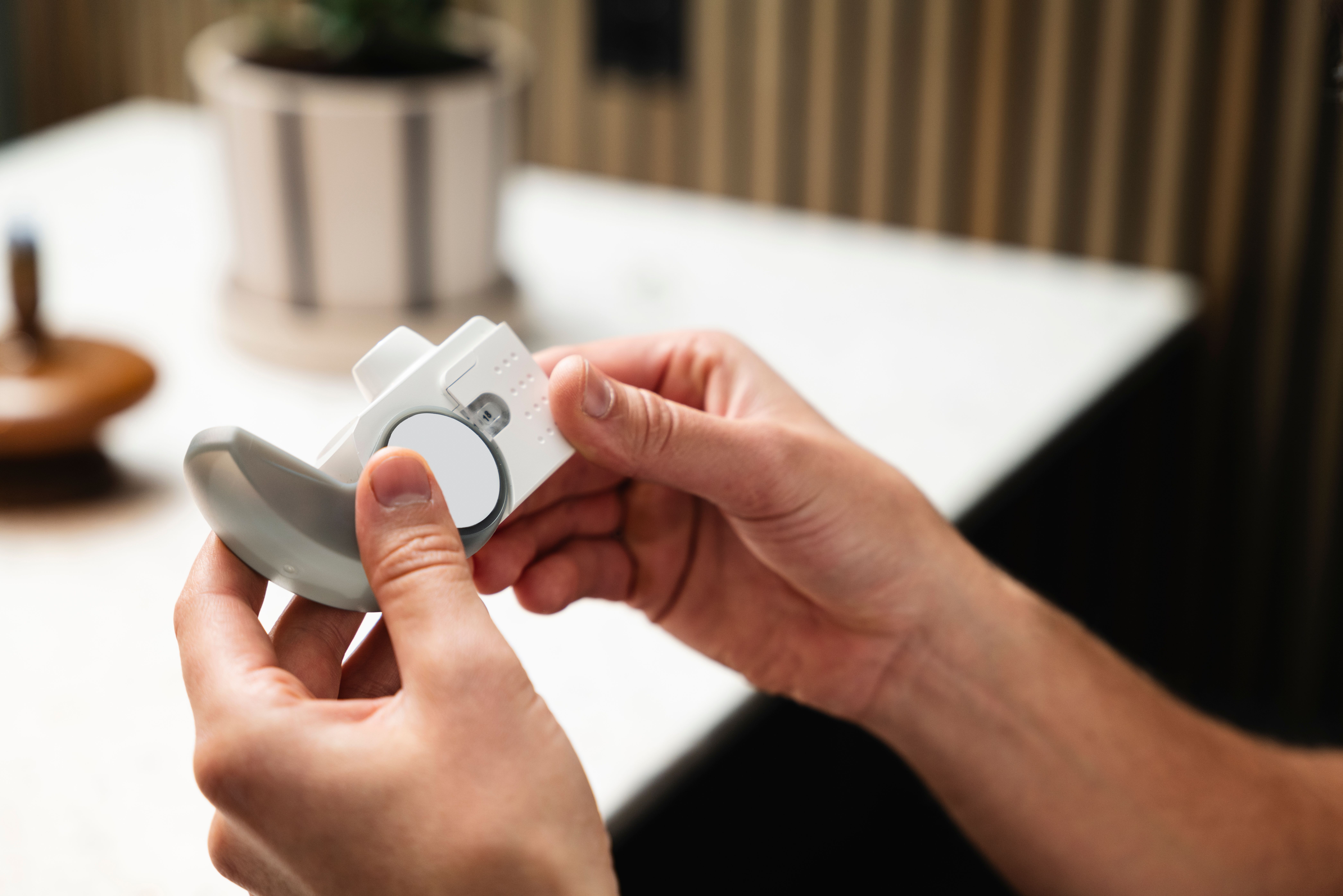 Person Holding Asthma Inhaler Device Indoors · Free Stock Photo