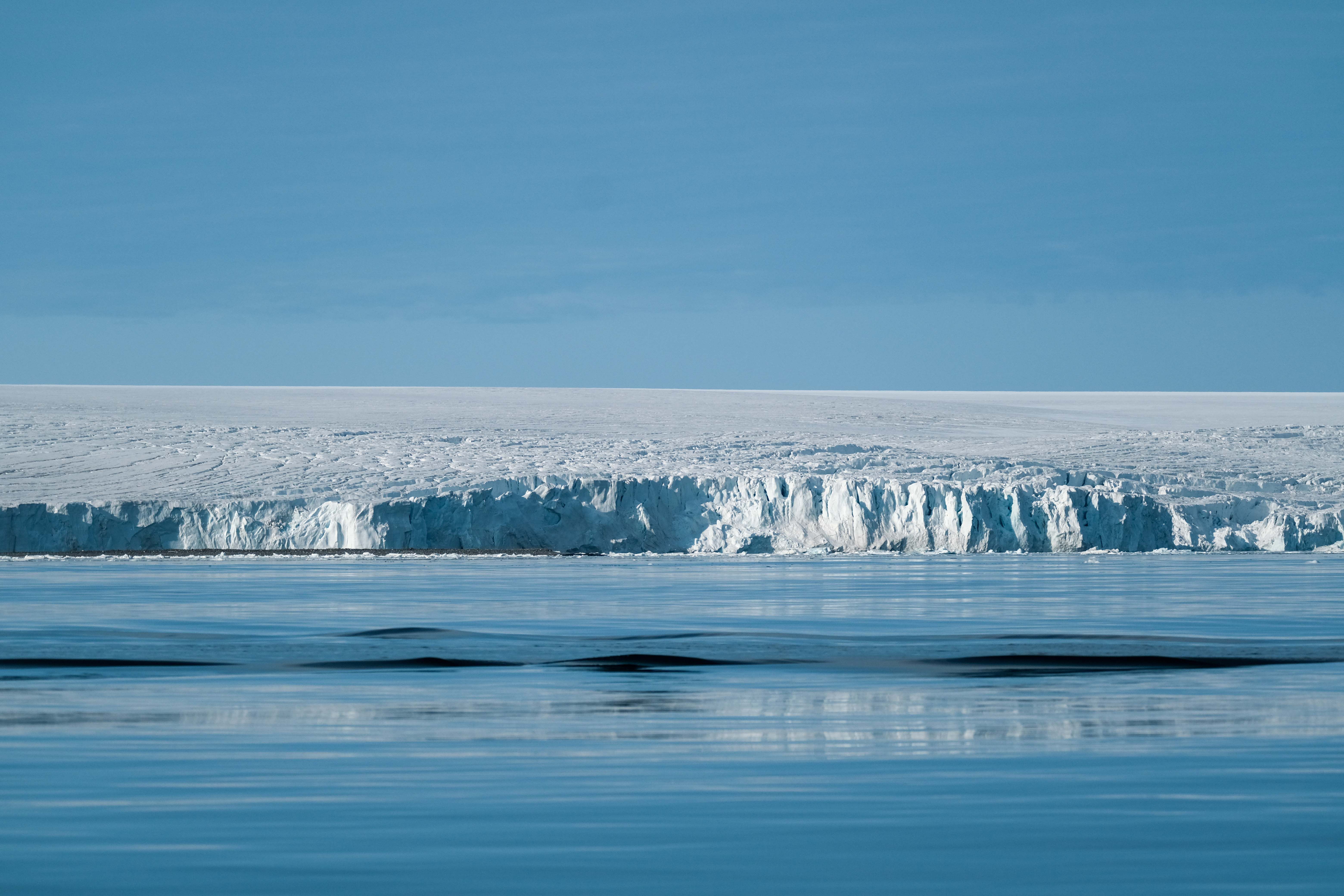 Expansive Antarctic Ice Shelf and Tranquil Sea · Free Stock Photo
