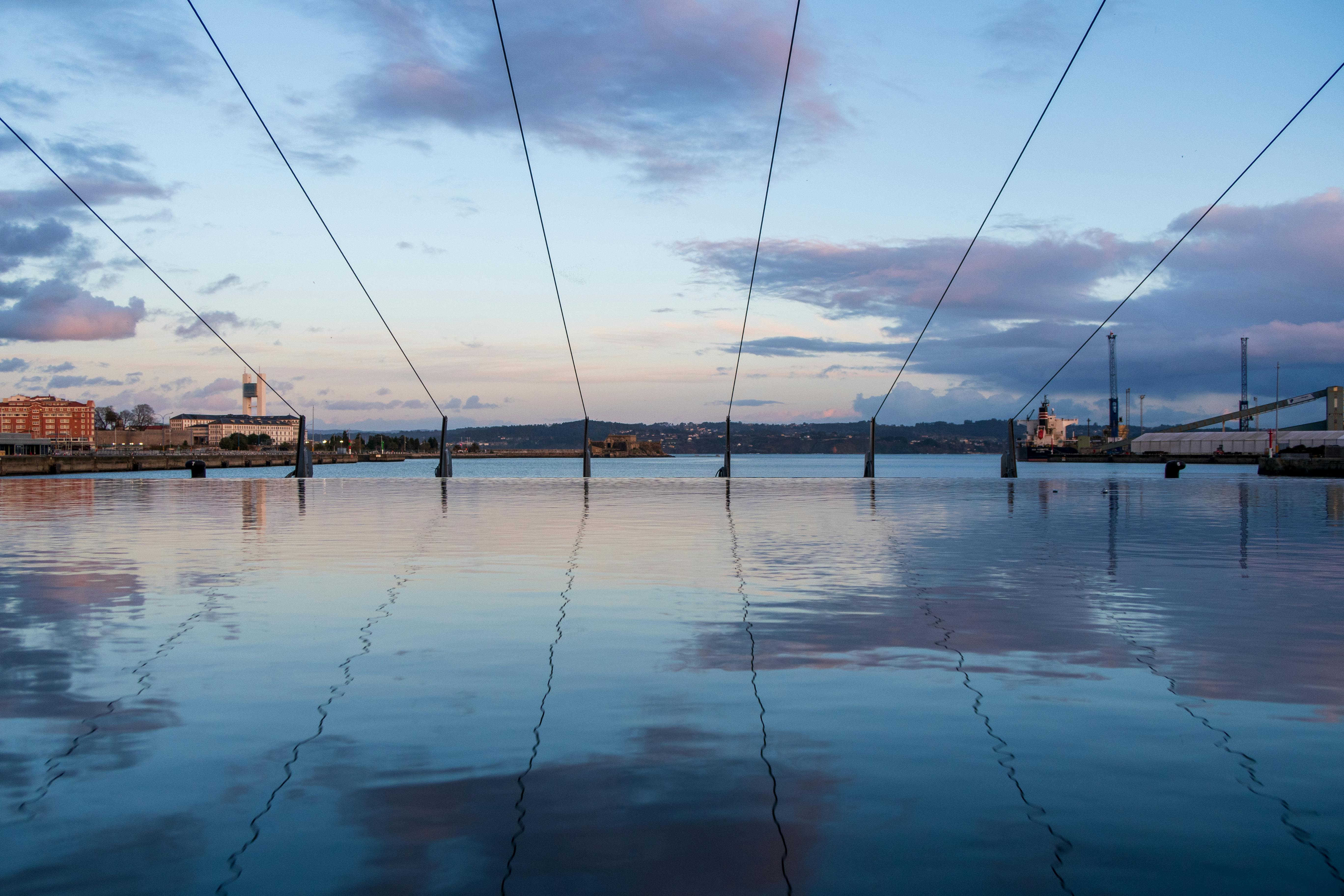 Tranquil Waterfront at Sunset with Reflections · Free Stock Photo
