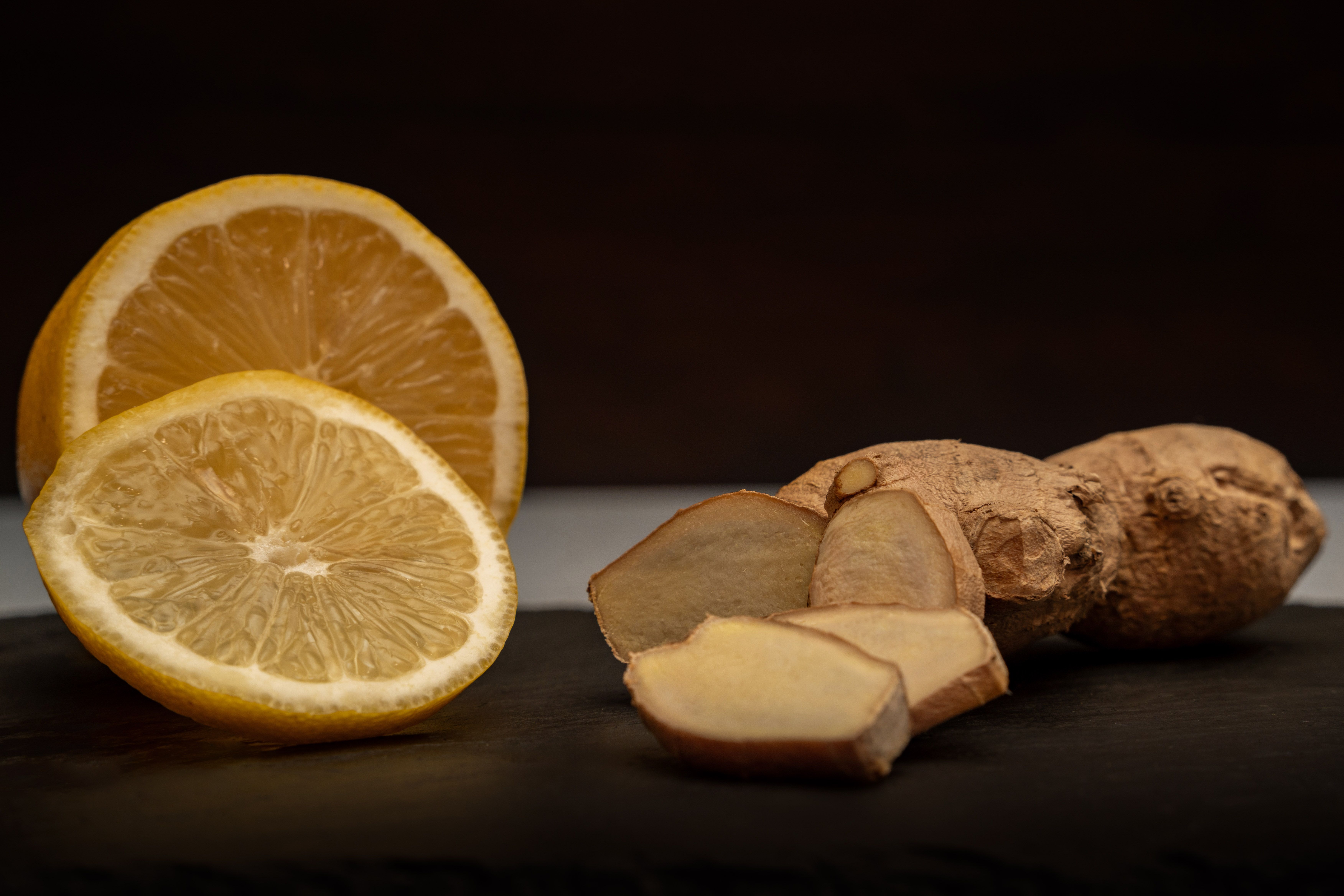 Fresh Ginger and Lemon Slices on Dark Background · Free Stock Photo