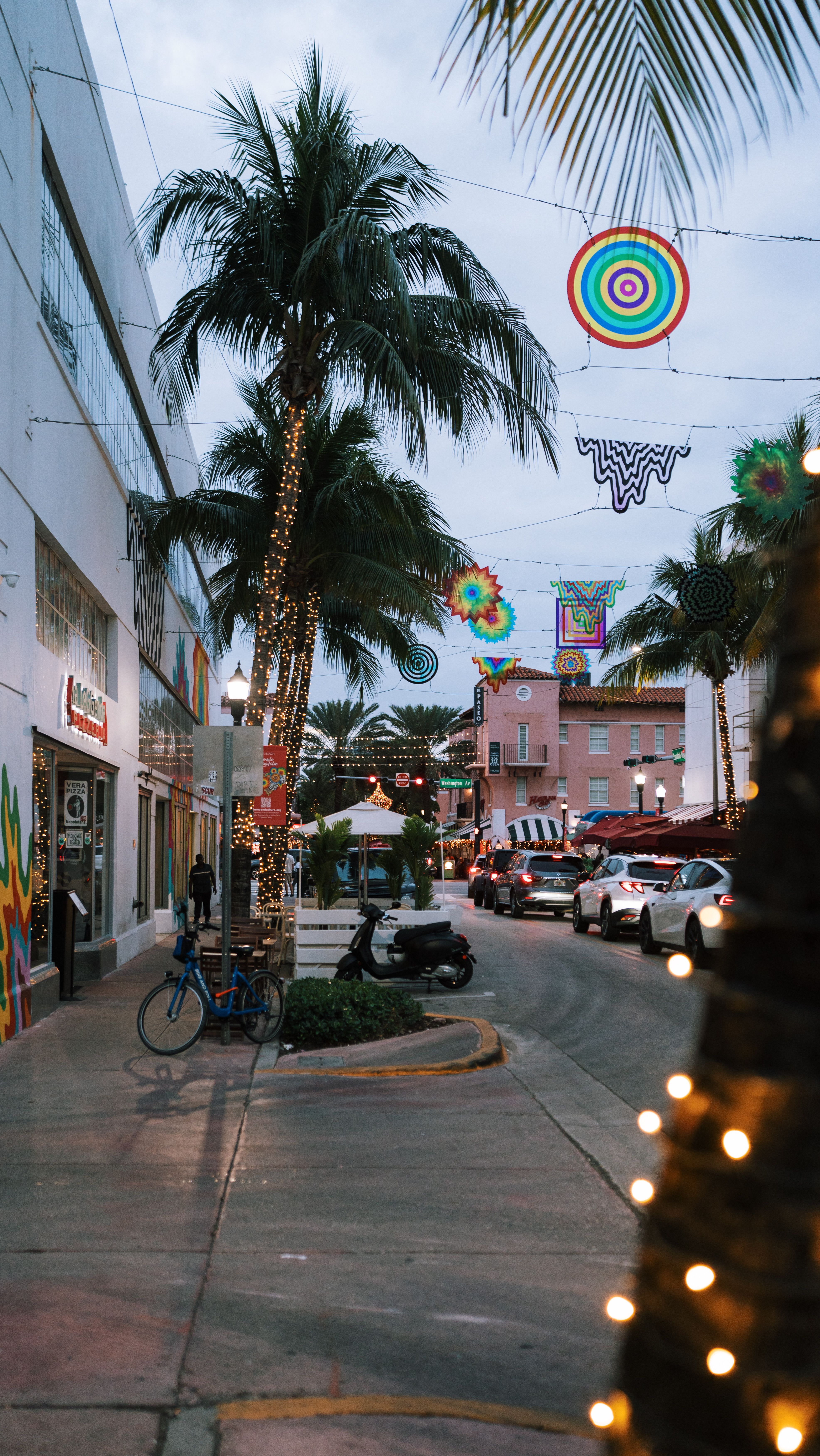 Vibrant street scene at dusk with festive lights · Free Stock Photo