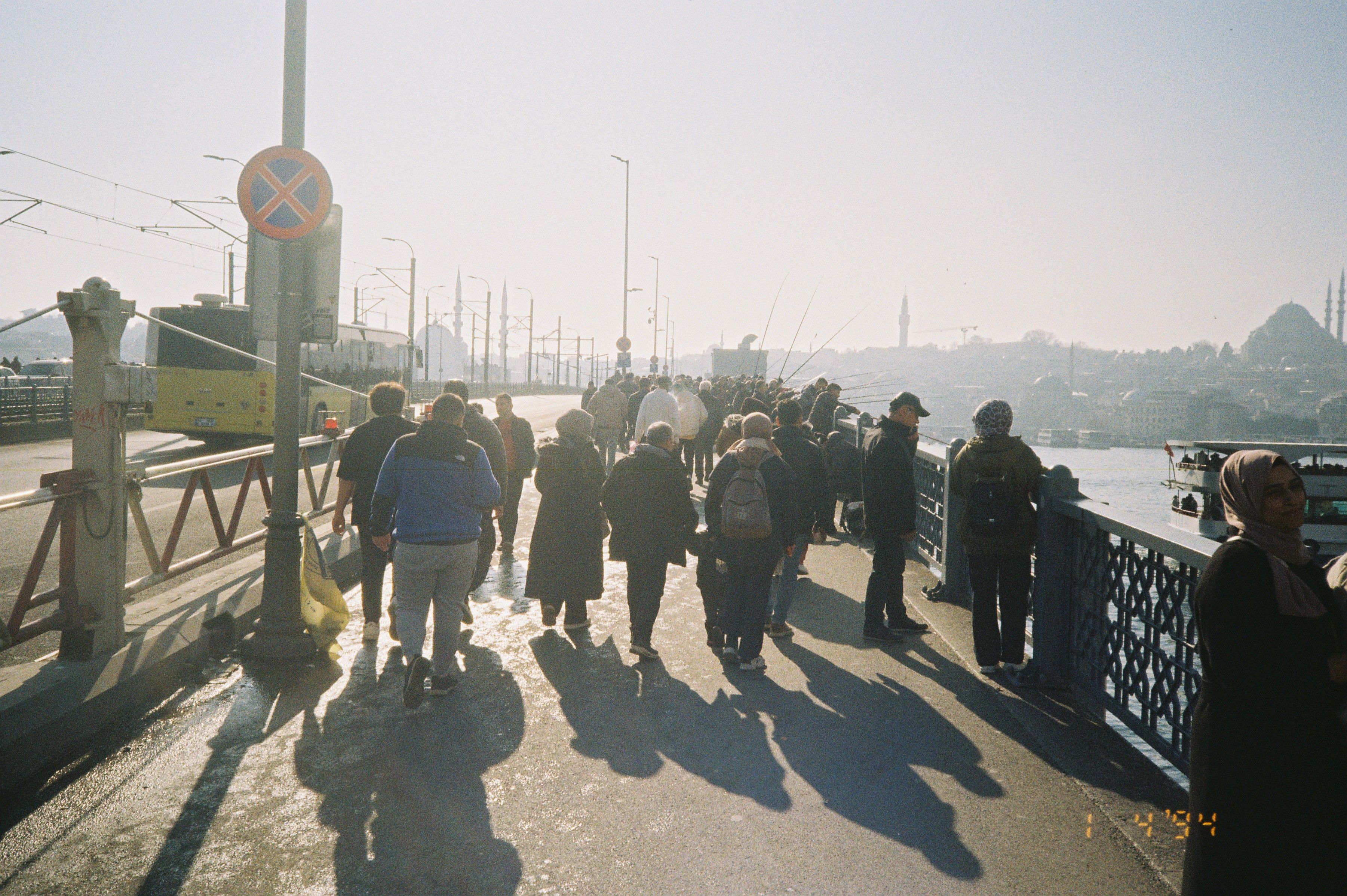 People Crossing a Sunny City Bridge View · Free Stock Photo