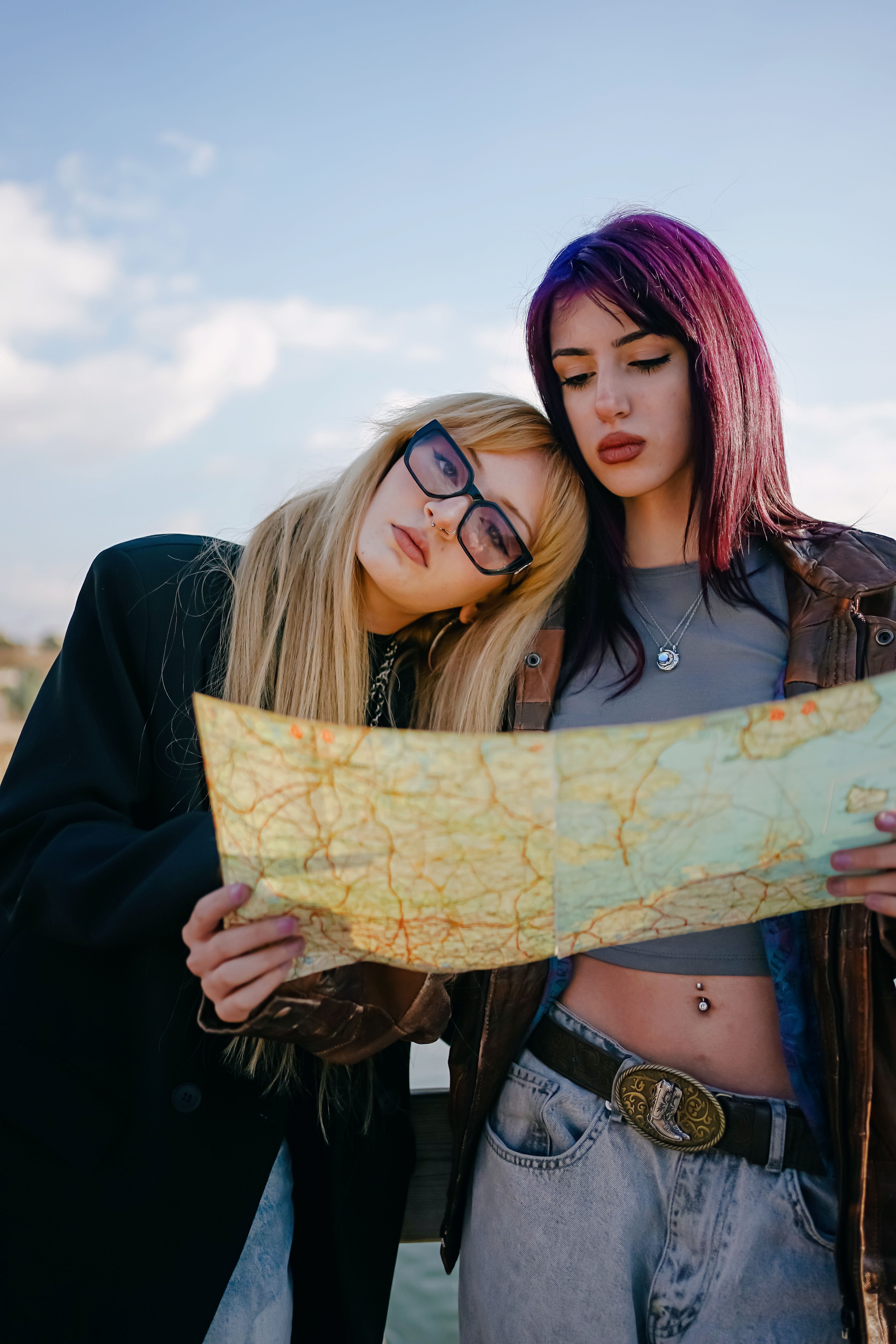 Young Friends Exploring with a Map on a Sunny Day · Free Stock Photo