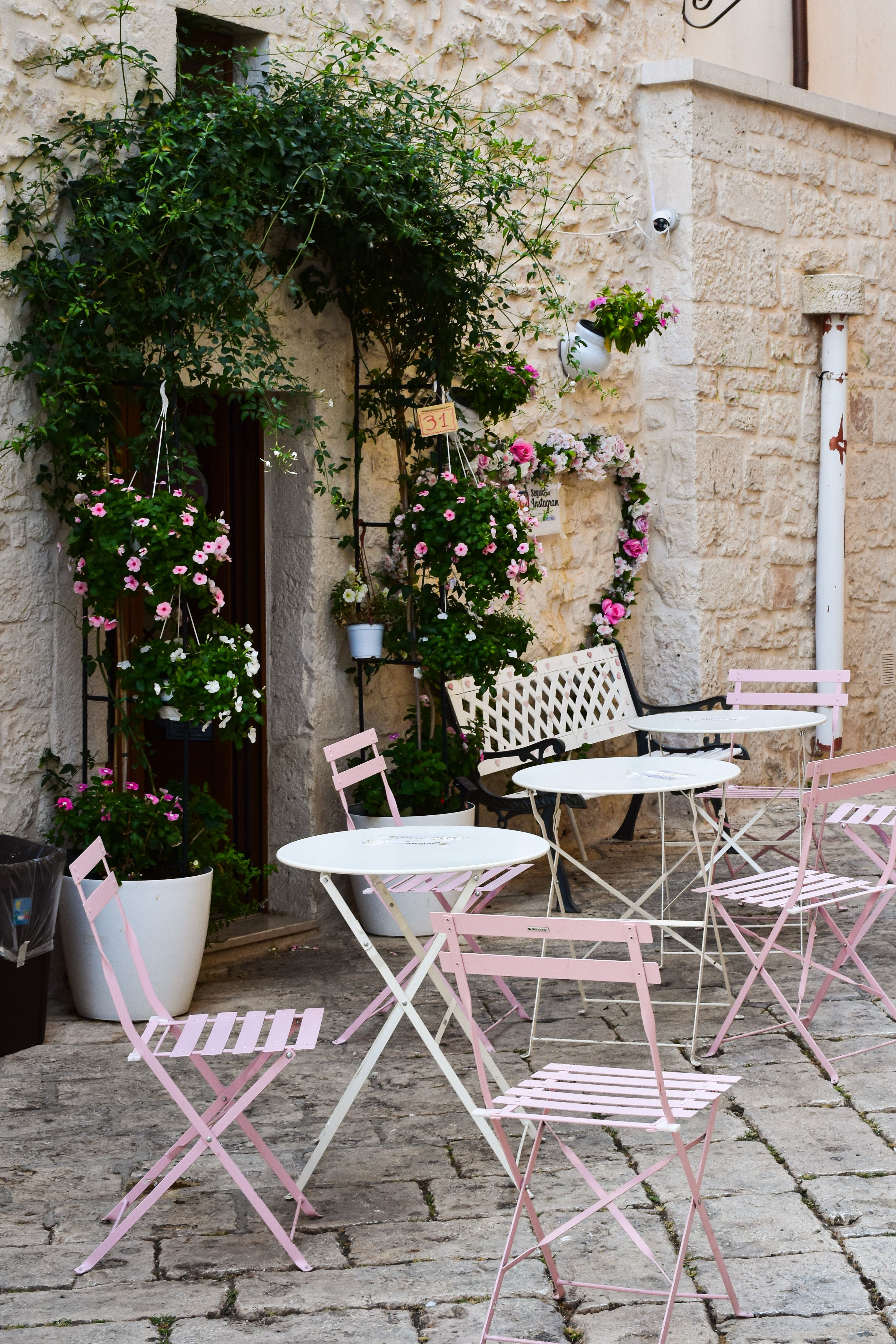 Charming Italian Courtyard with Pink Bistro Chairs · Free Stock Photo