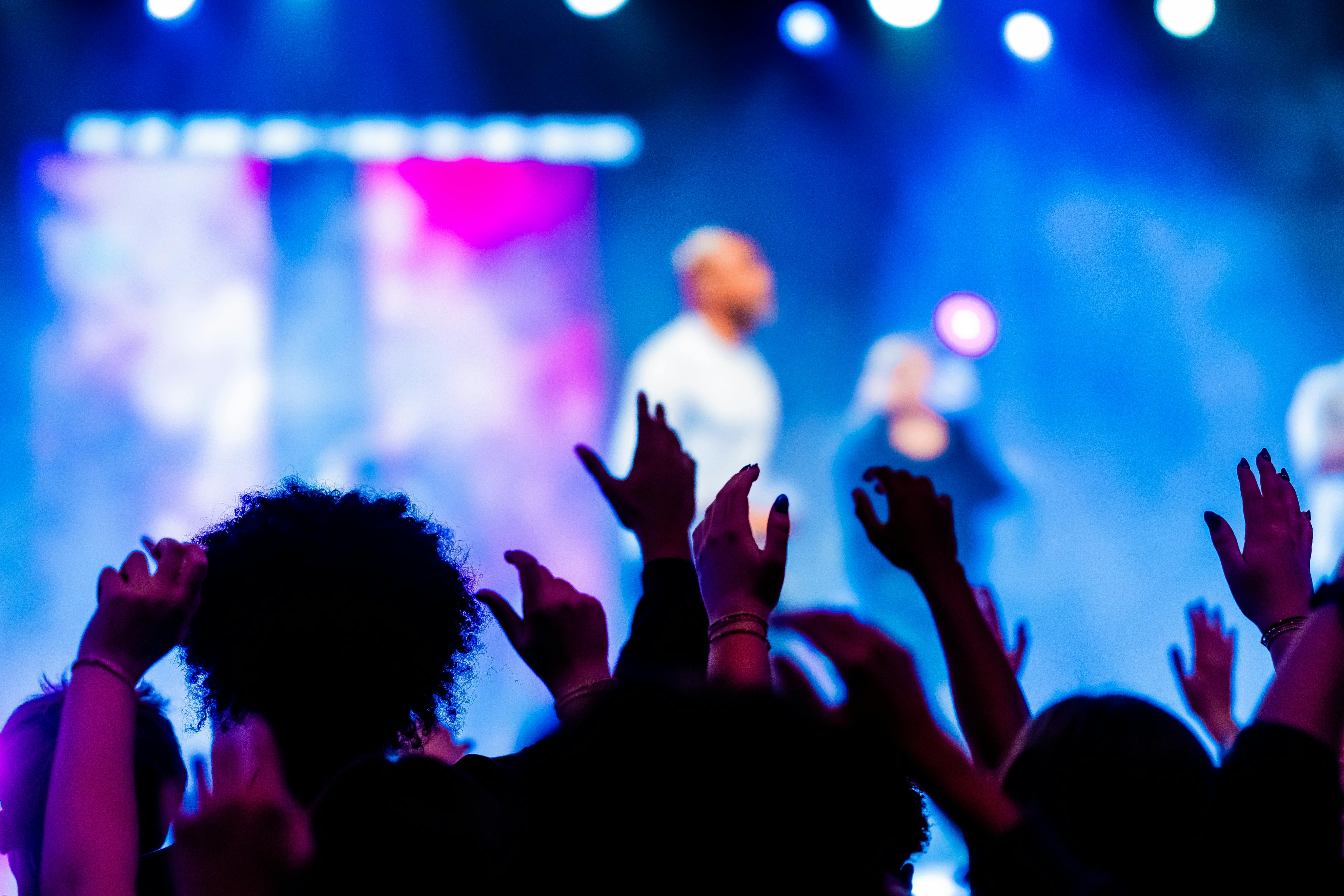 Crowd in Front of Blue and Orange Stage during a Concert at Night ...