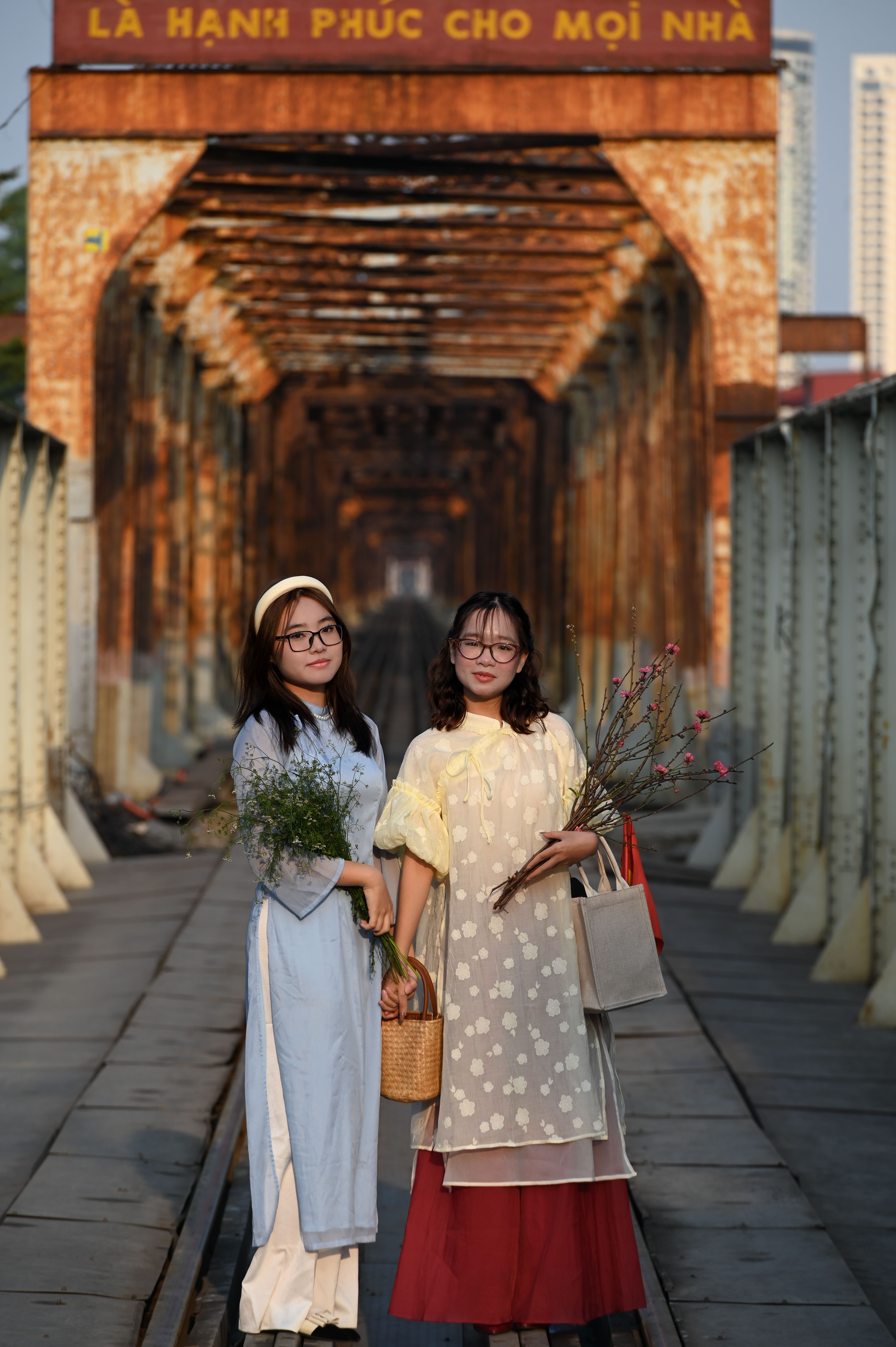 Two Women in Traditional Dresses on Iron Bridge · Free Stock Photo