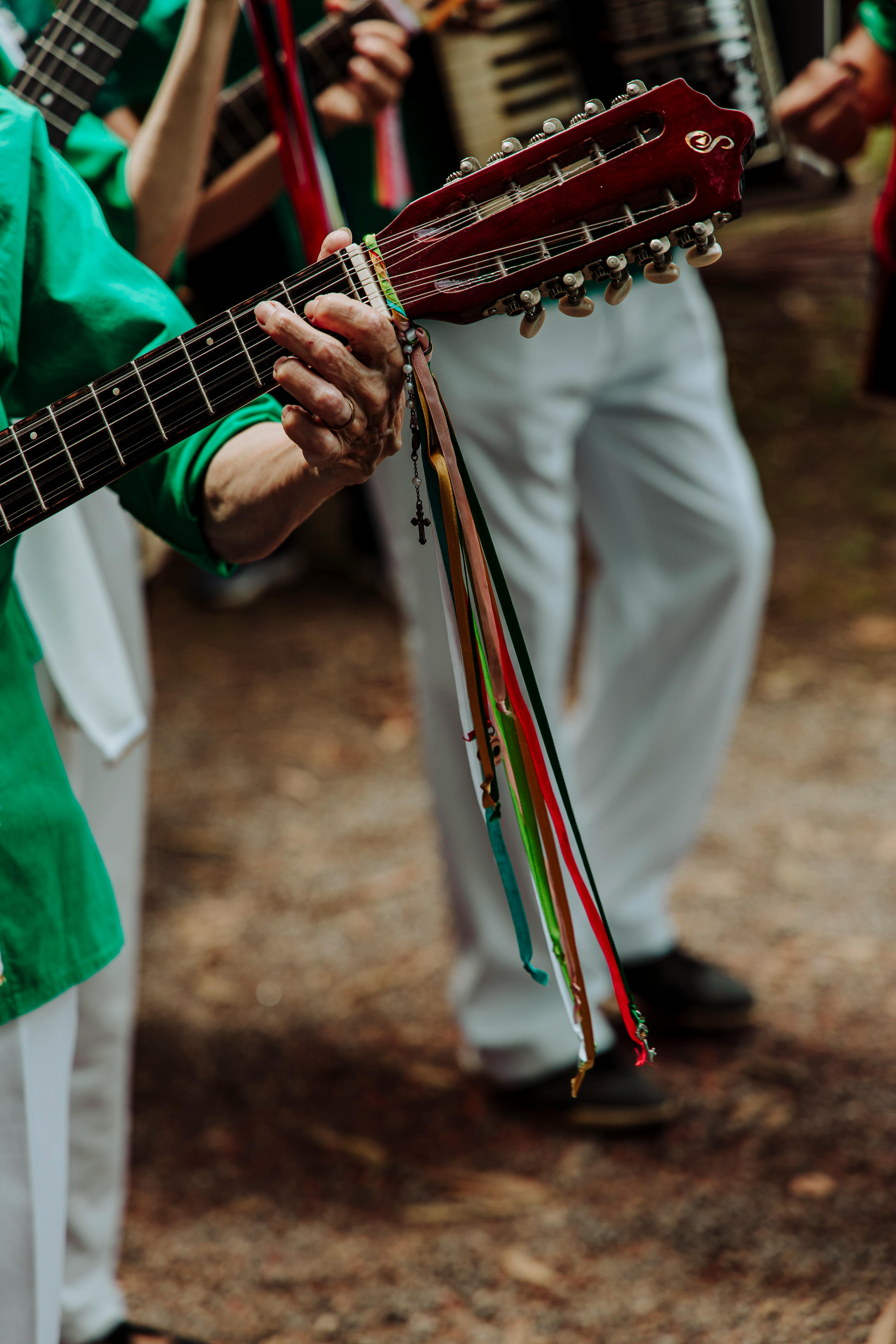 Traditional Brazilian Musician Playing Guitar Outdoors · Free Stock Photo