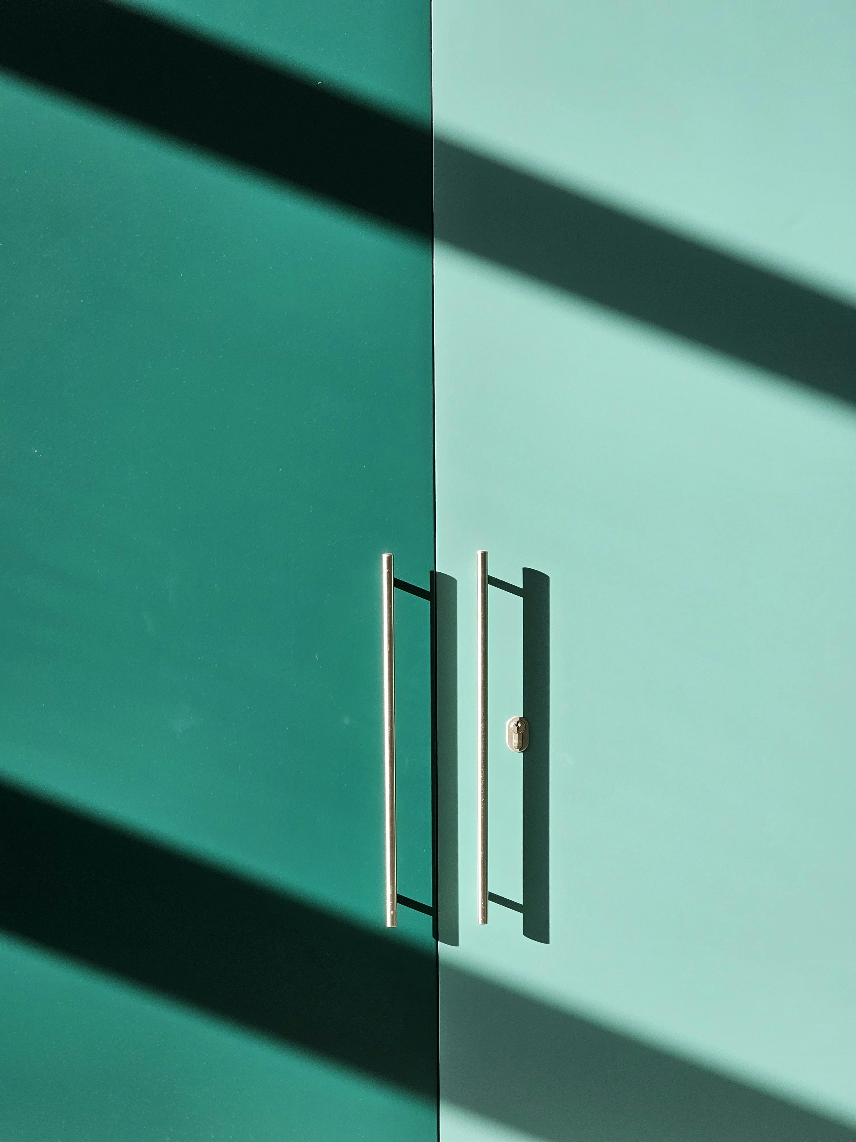 Elegant Teal Doors with Shadow Play · Free Stock Photo