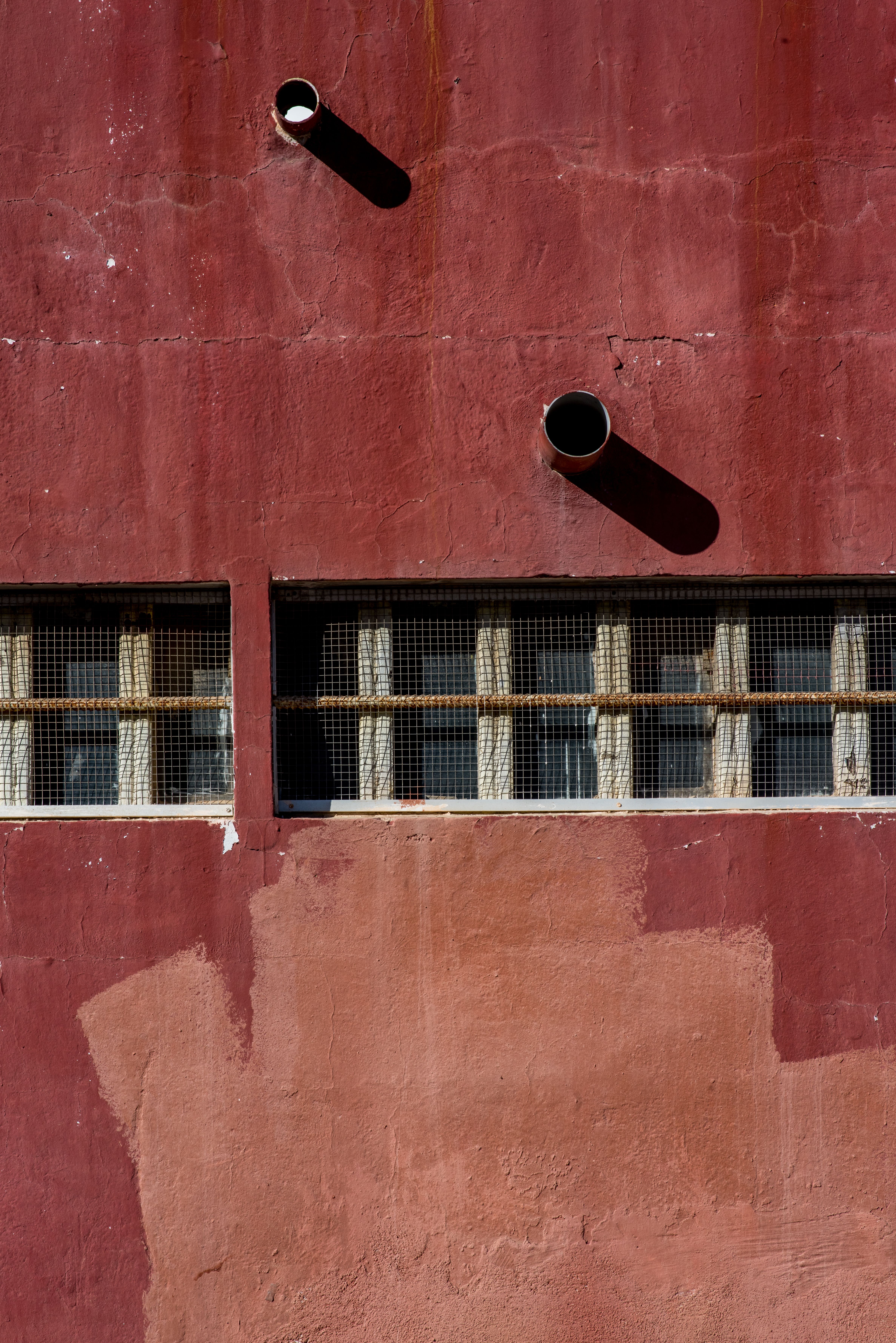 Red Industrial Wall with Pipes and Windows · Free Stock Photo