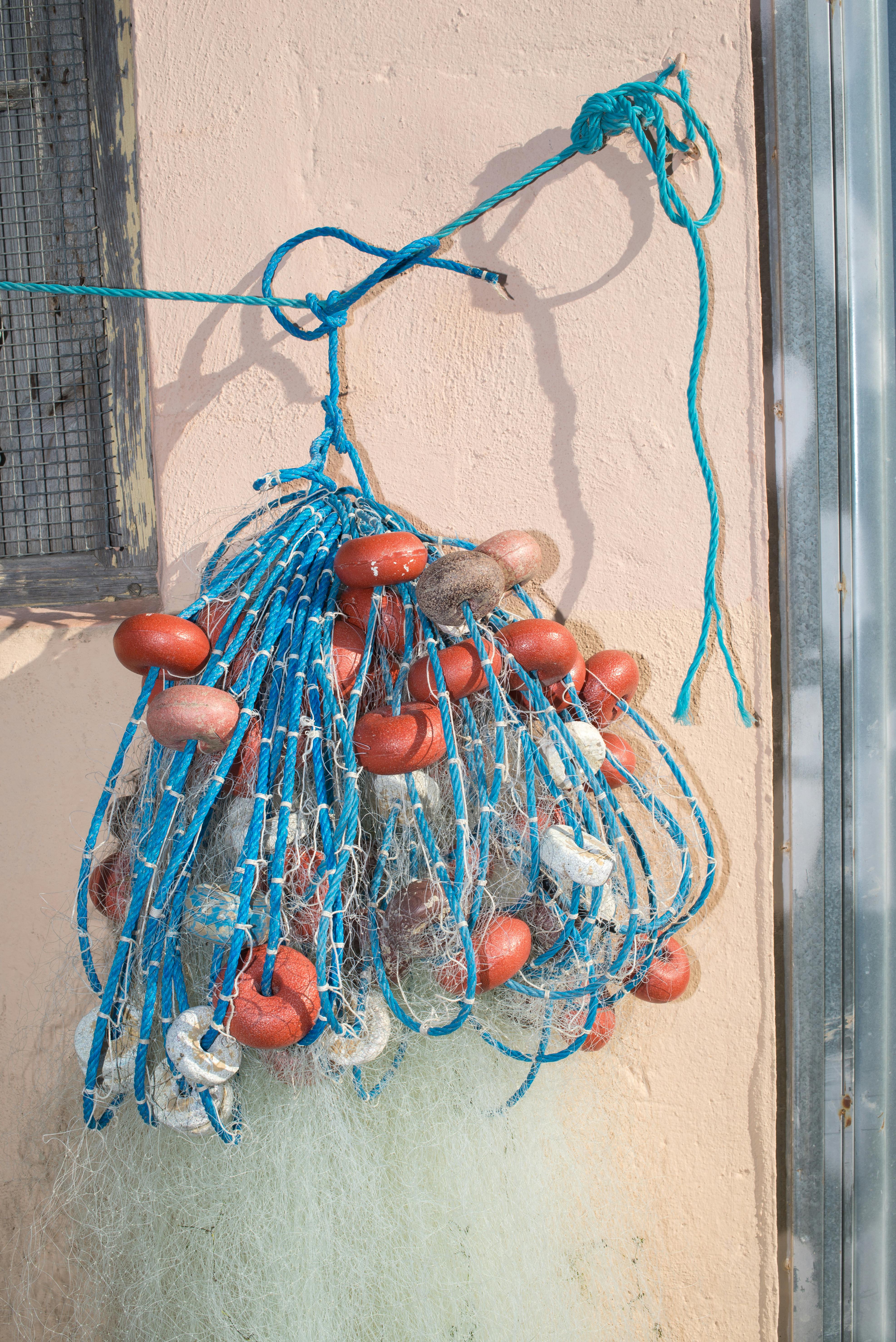 Colorful Fishing Nets Hanging on Wall Outdoors · Free Stock Photo