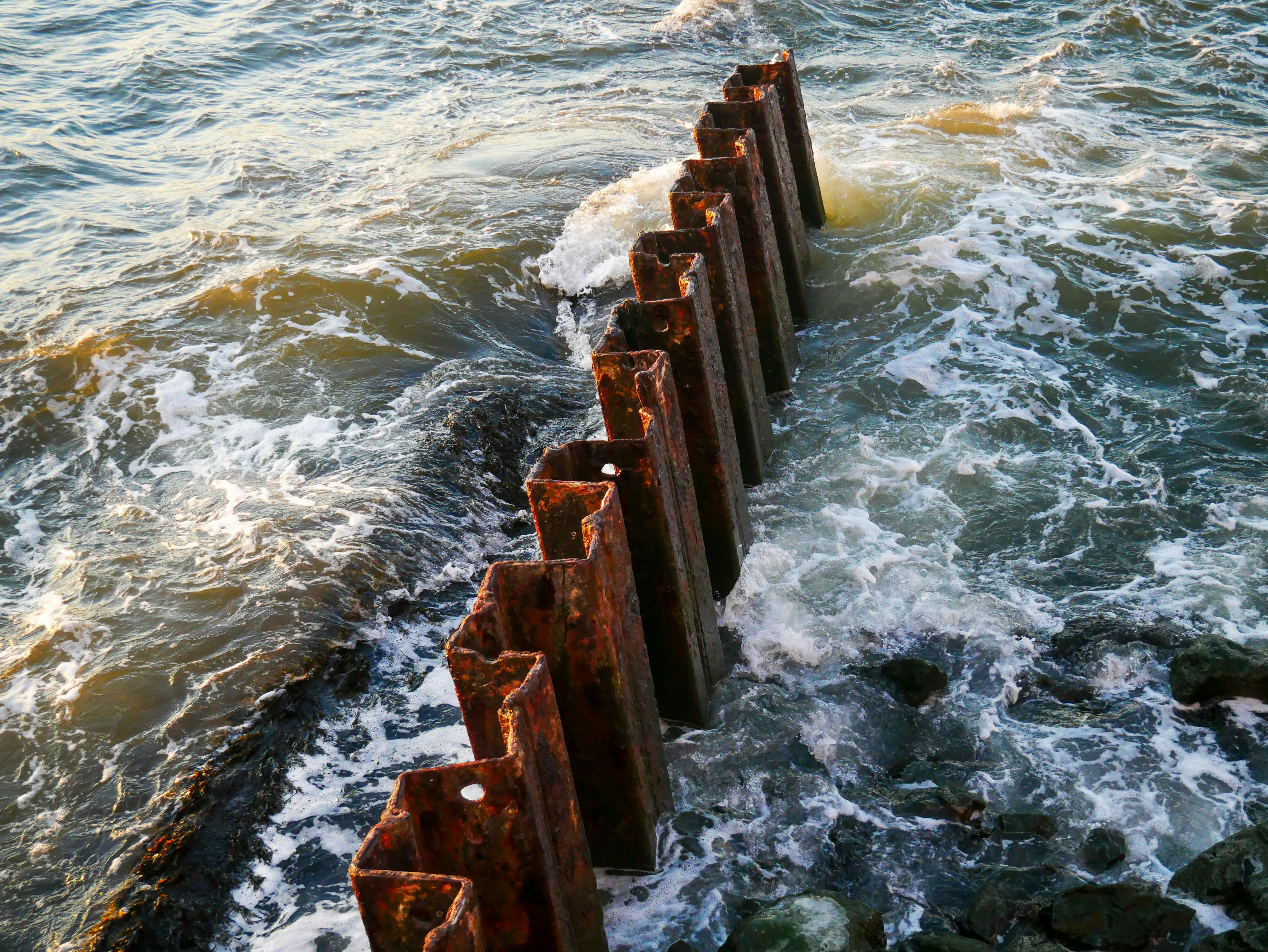 Rusty Sea Defense Structures in Ocean Waves · Free Stock Photo