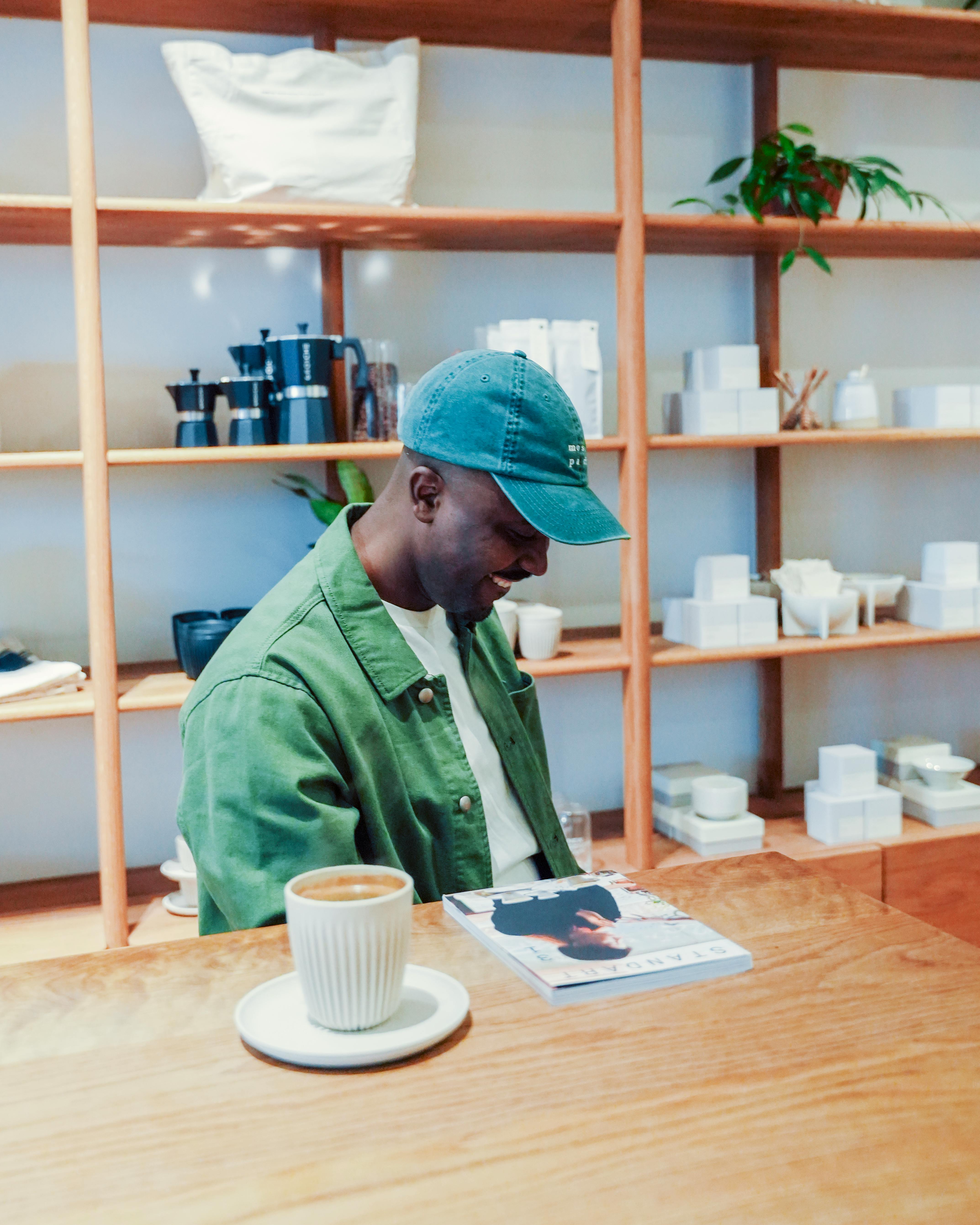 Man Enjoying Coffee at Modern Cafe Workspace · Free Stock Photo