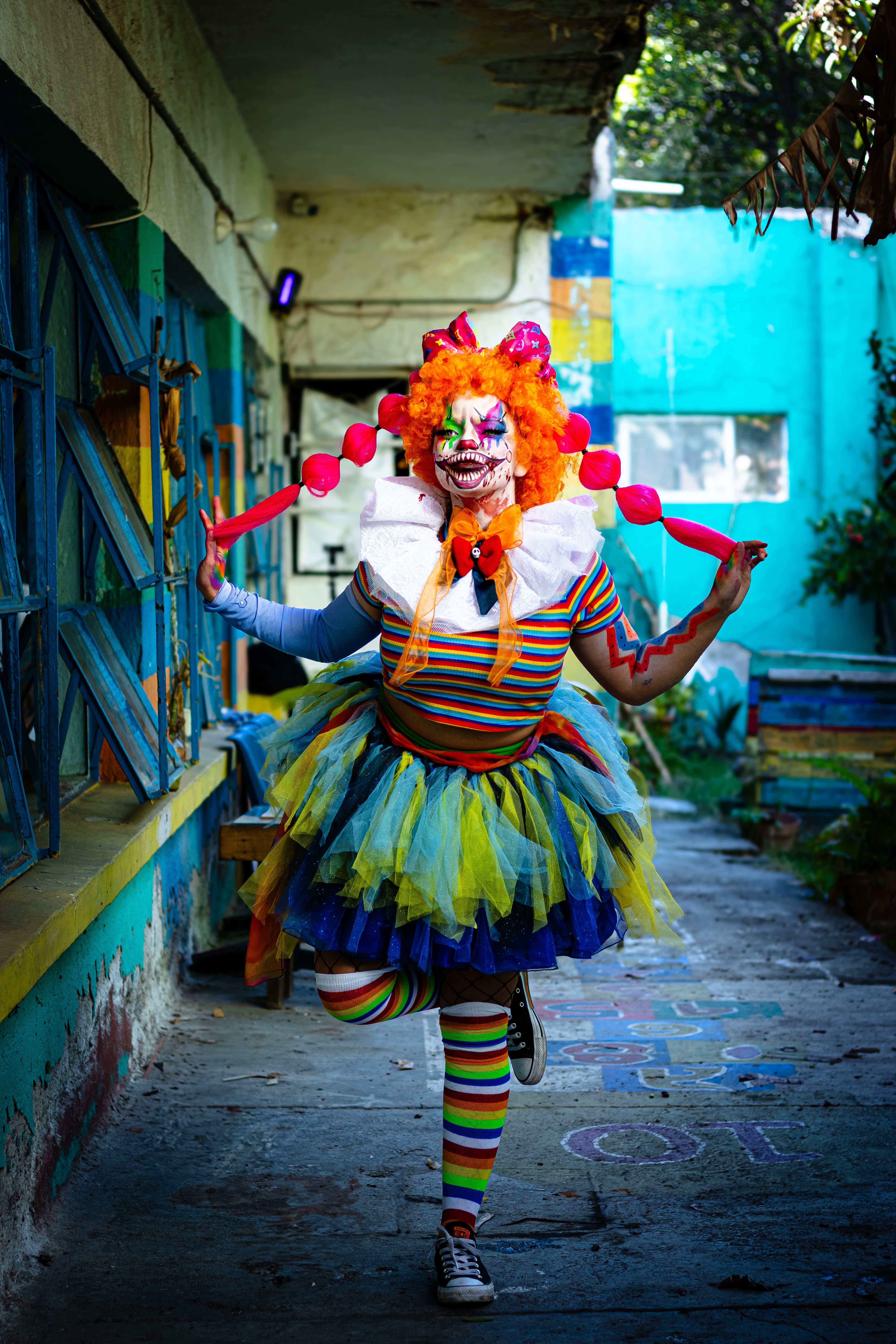 Colorful Clown Performing in Vibrant Alley · Free Stock Photo