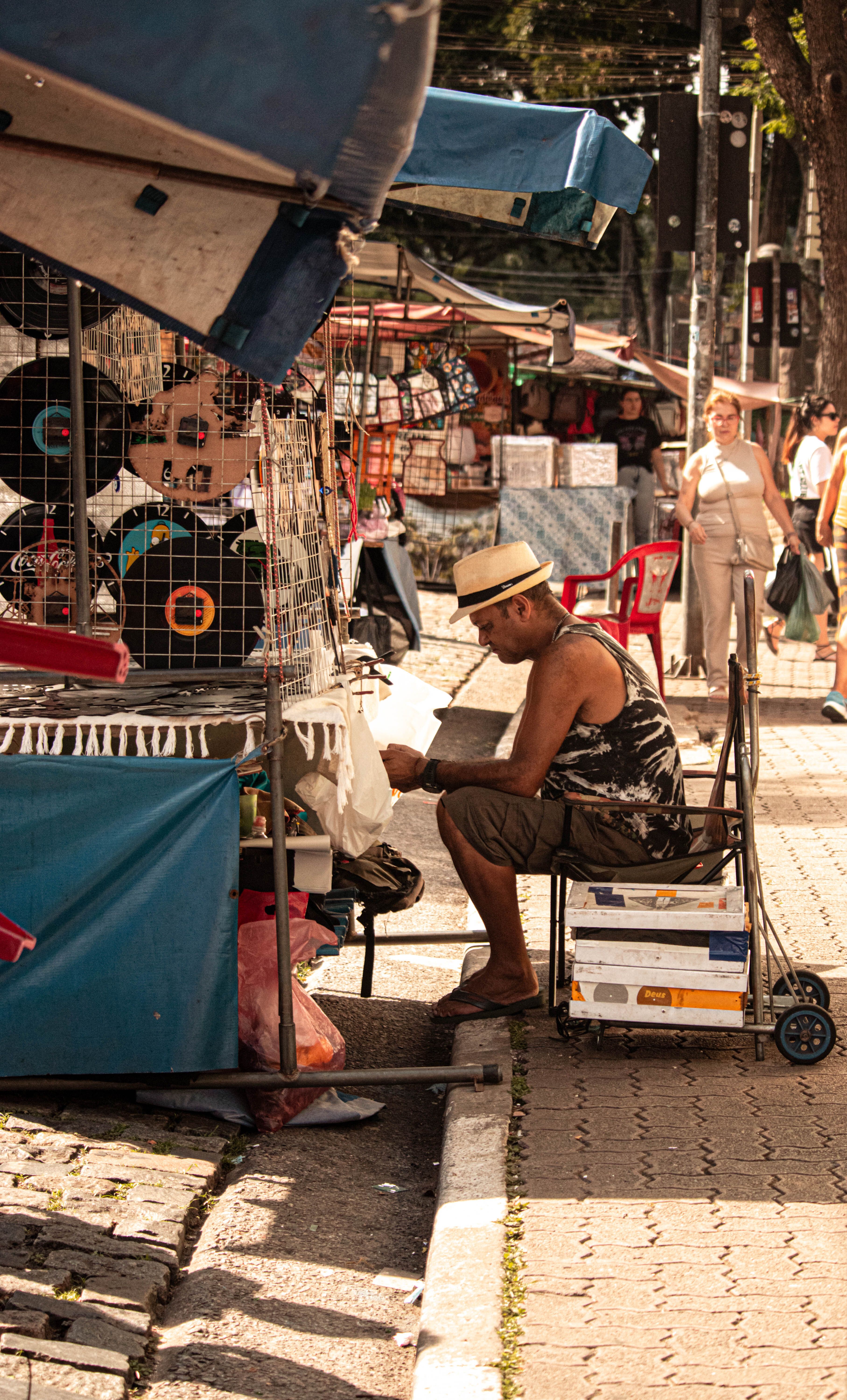 Man at Outdoor Market Stall During Daytime · Free Stock Photo