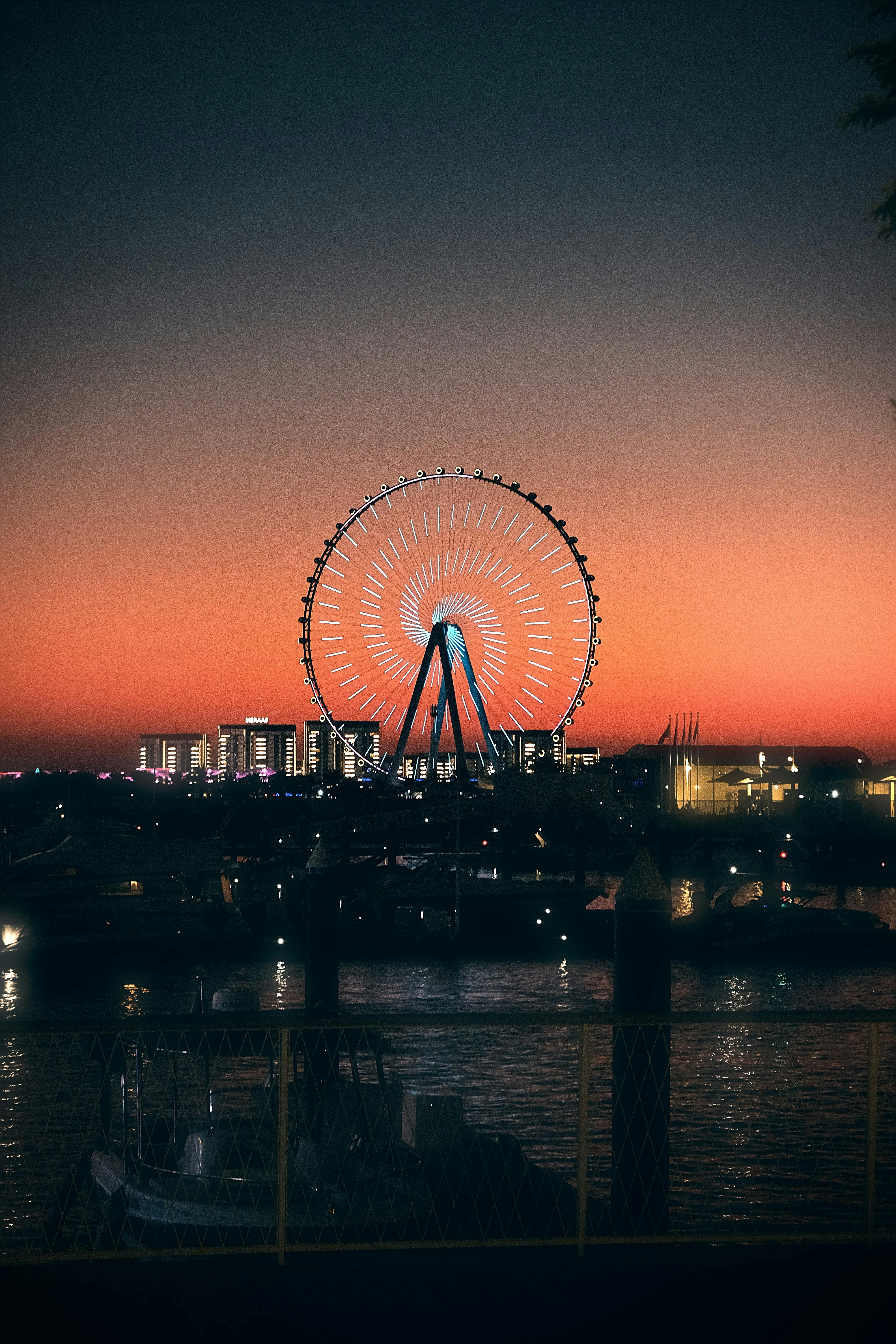 Stunning Twilight View of Dubai's Iconic Ferris Wheel · Free Stock Photo