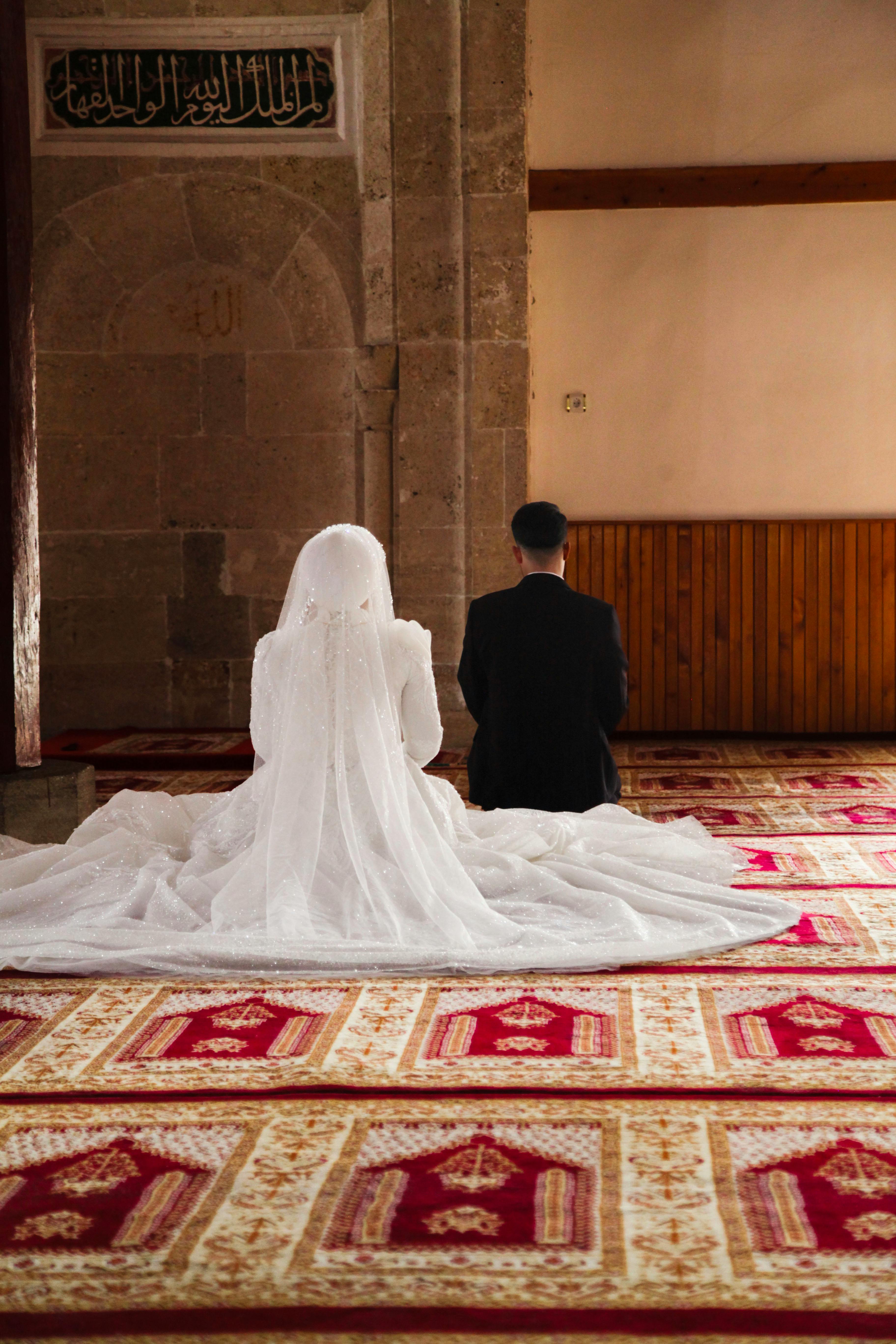 Bride and Groom Praying in Mosque Interior · Free Stock Photo