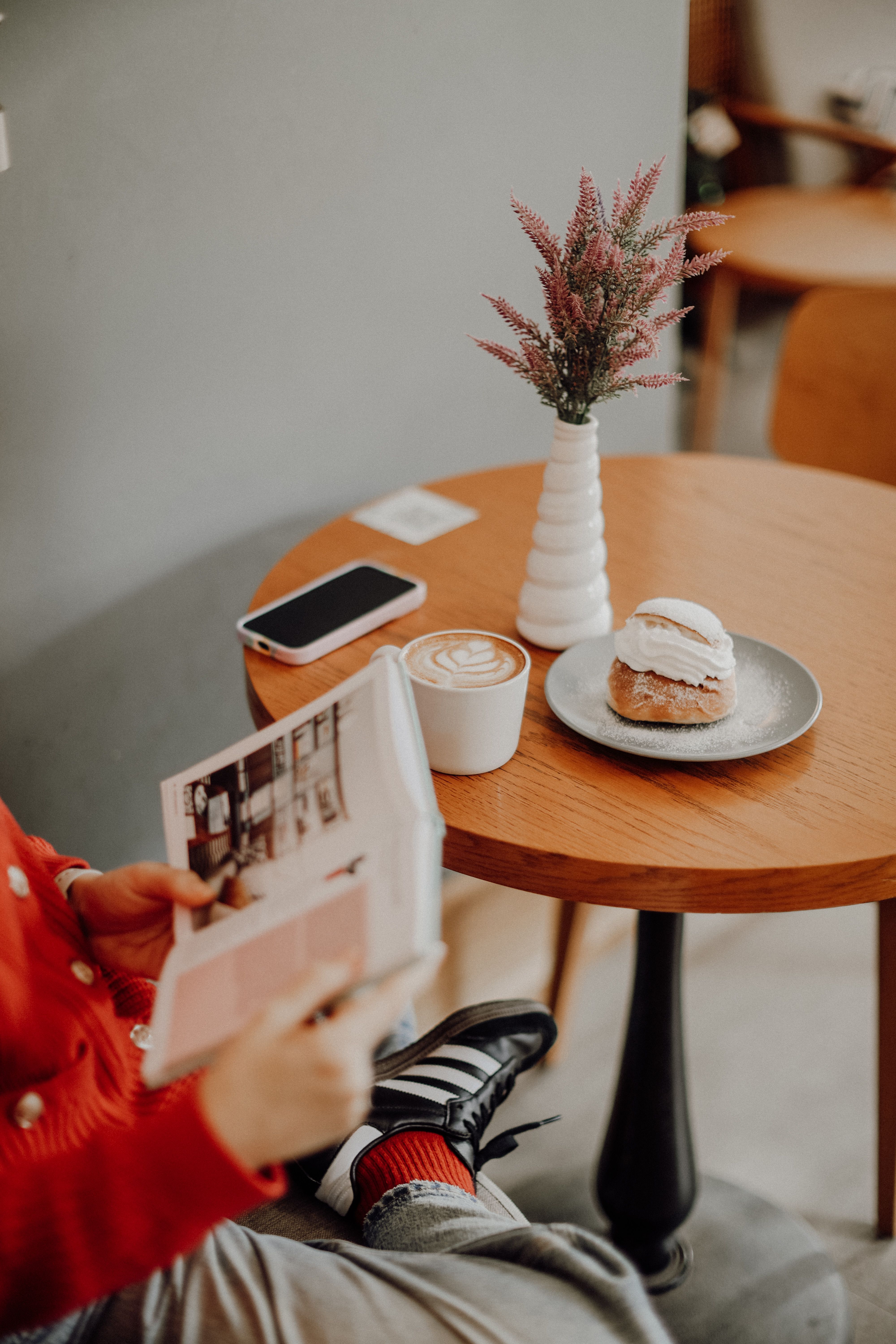 Cozy Cafe Reading with Coffee and Semla · Free Stock Photo