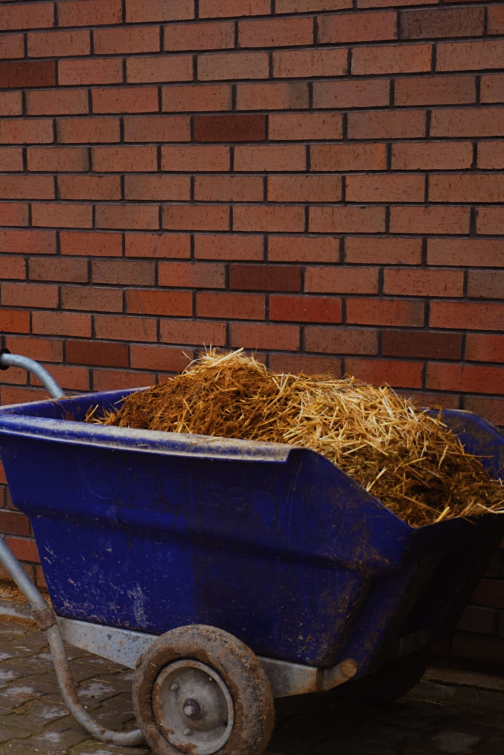 Wheelbarrow with Hay Against Brick Wall in Eskişehir · Free Stock Photo