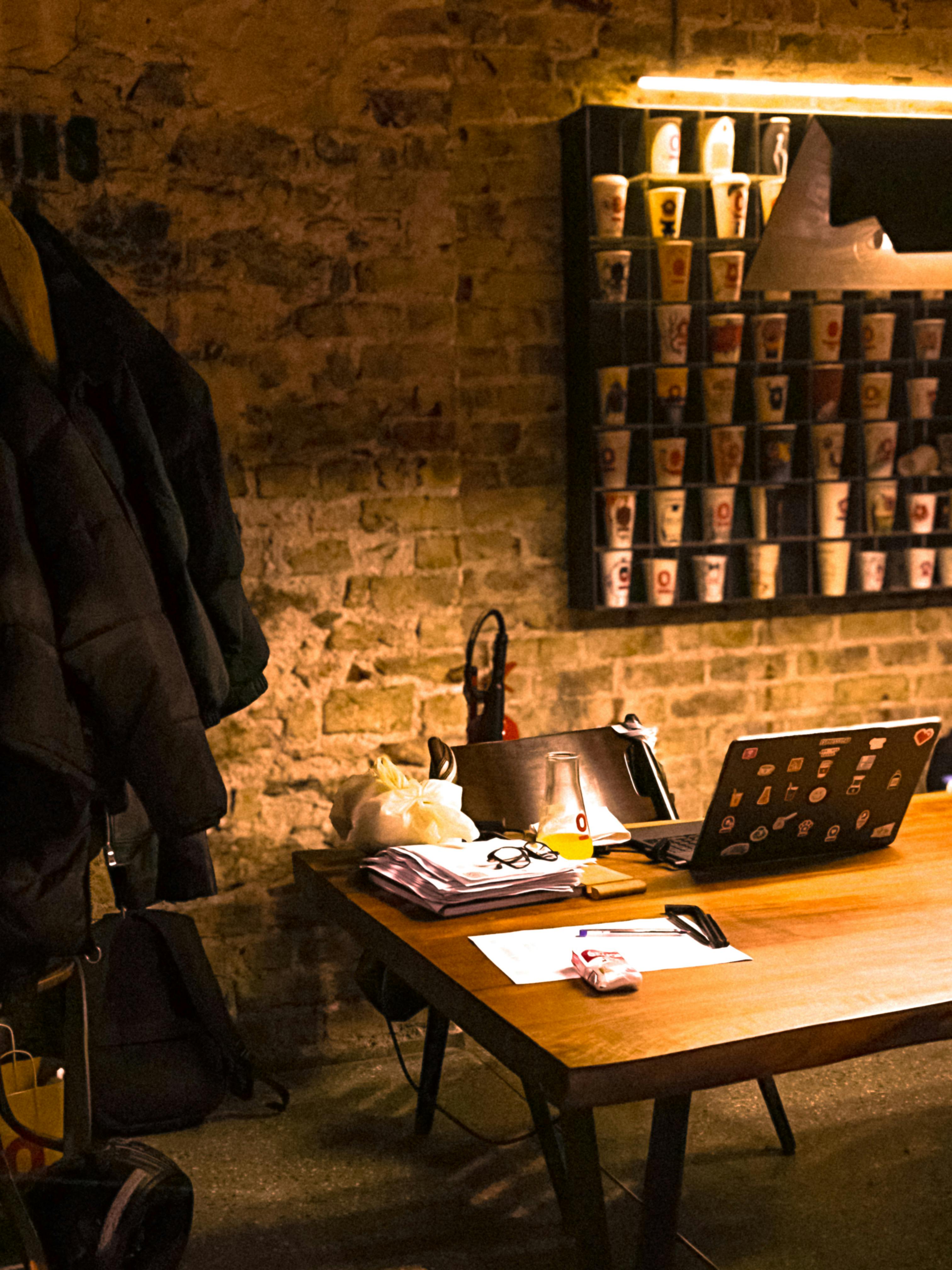 Cozy Café Workspace with Exposed Brick Wall · Free Stock Photo