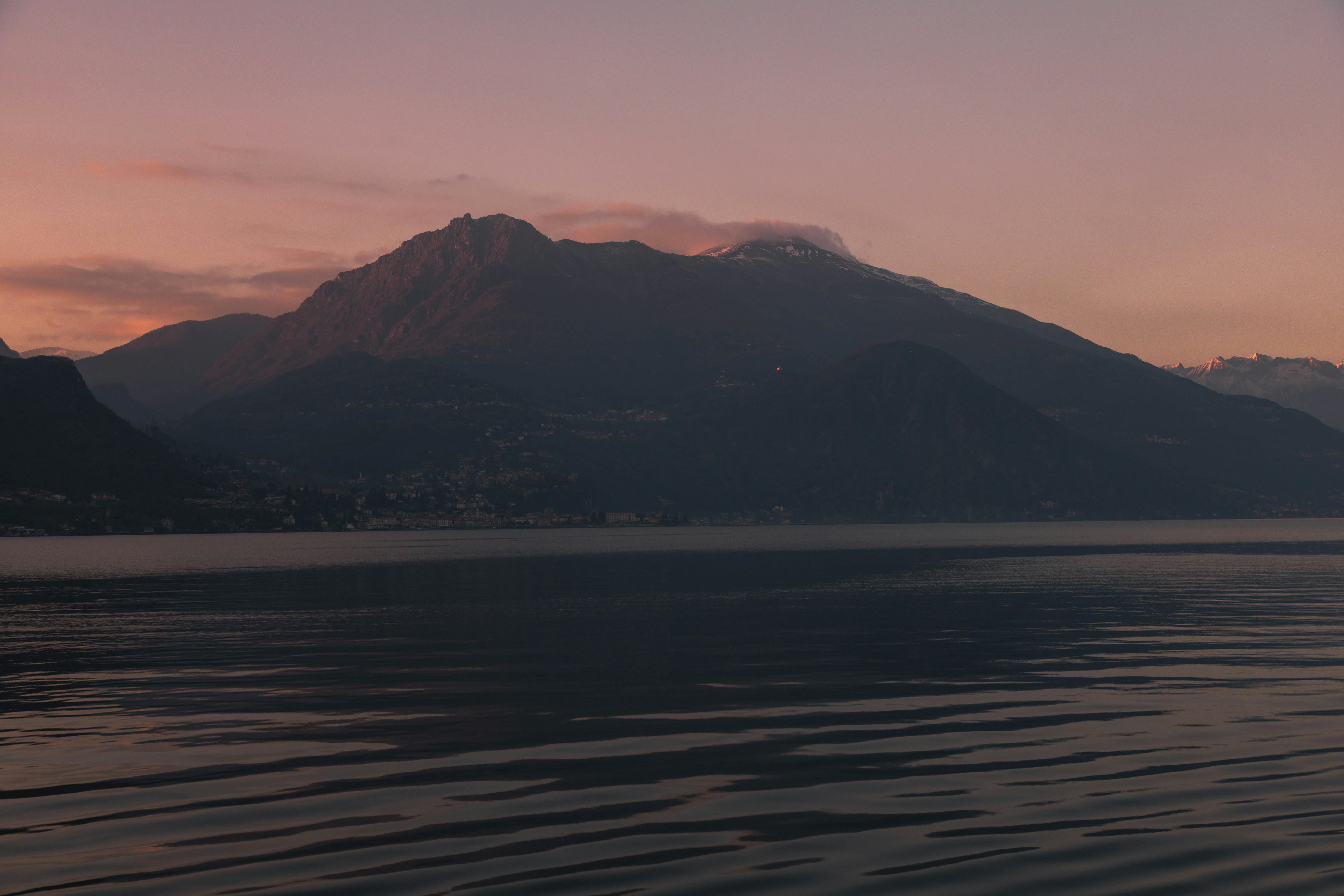 Serene Lake Como Sunset with Distant Mountains · Free Stock Photo