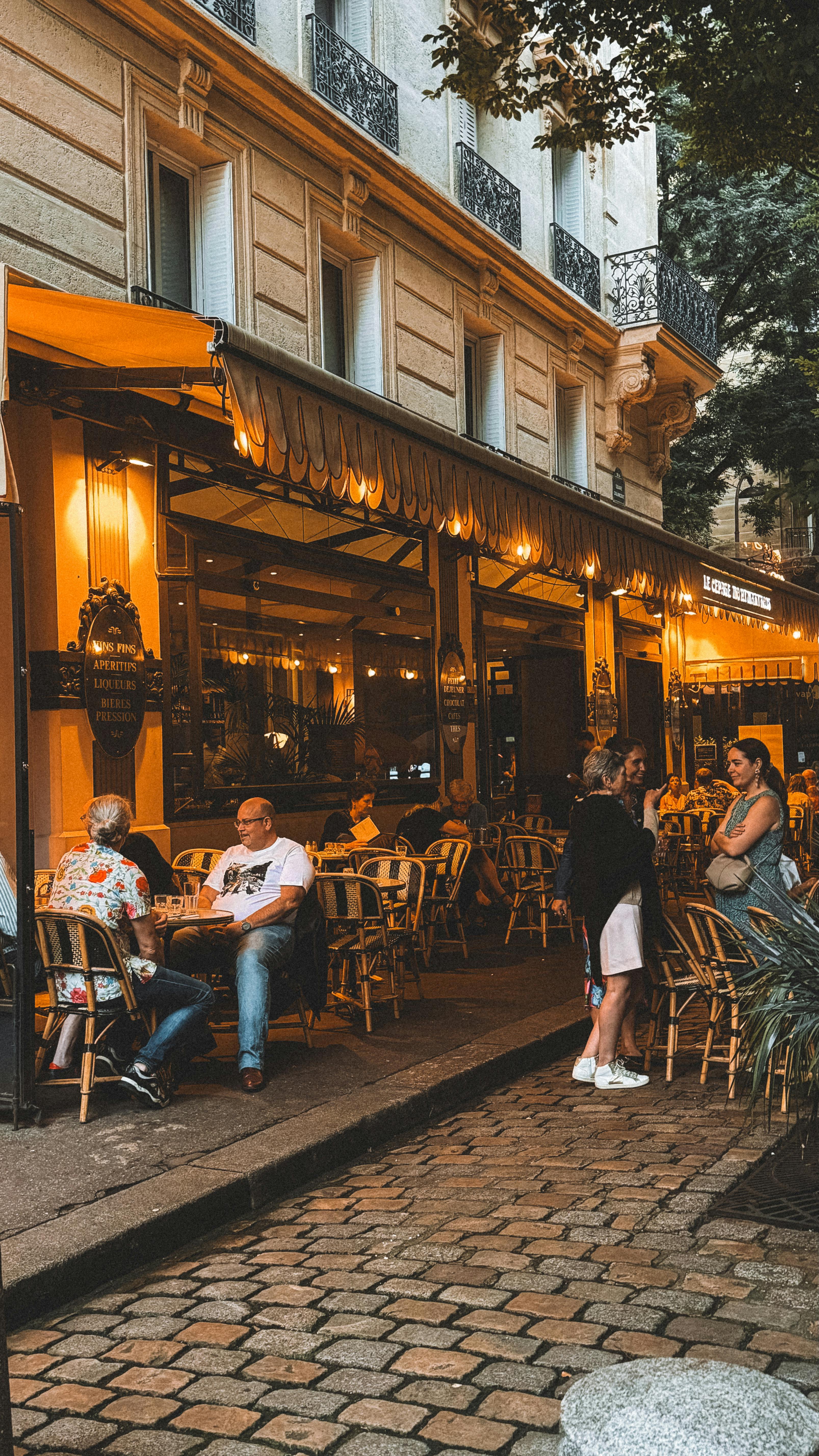 Charming Parisian Cafe in Evening Light · Free Stock Photo