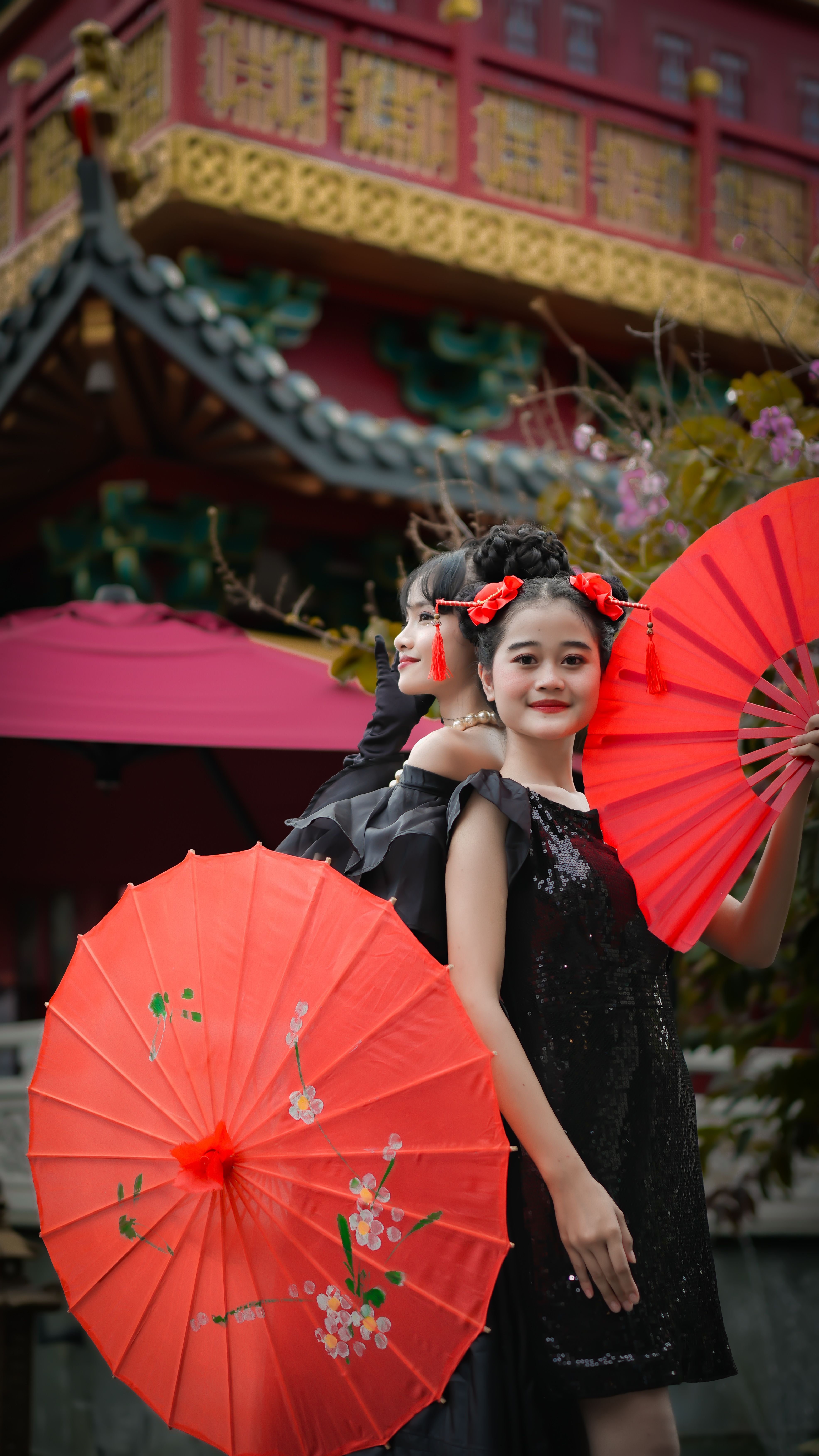 Traditional Asian Fashion with Red Umbrellas · Free Stock Photo