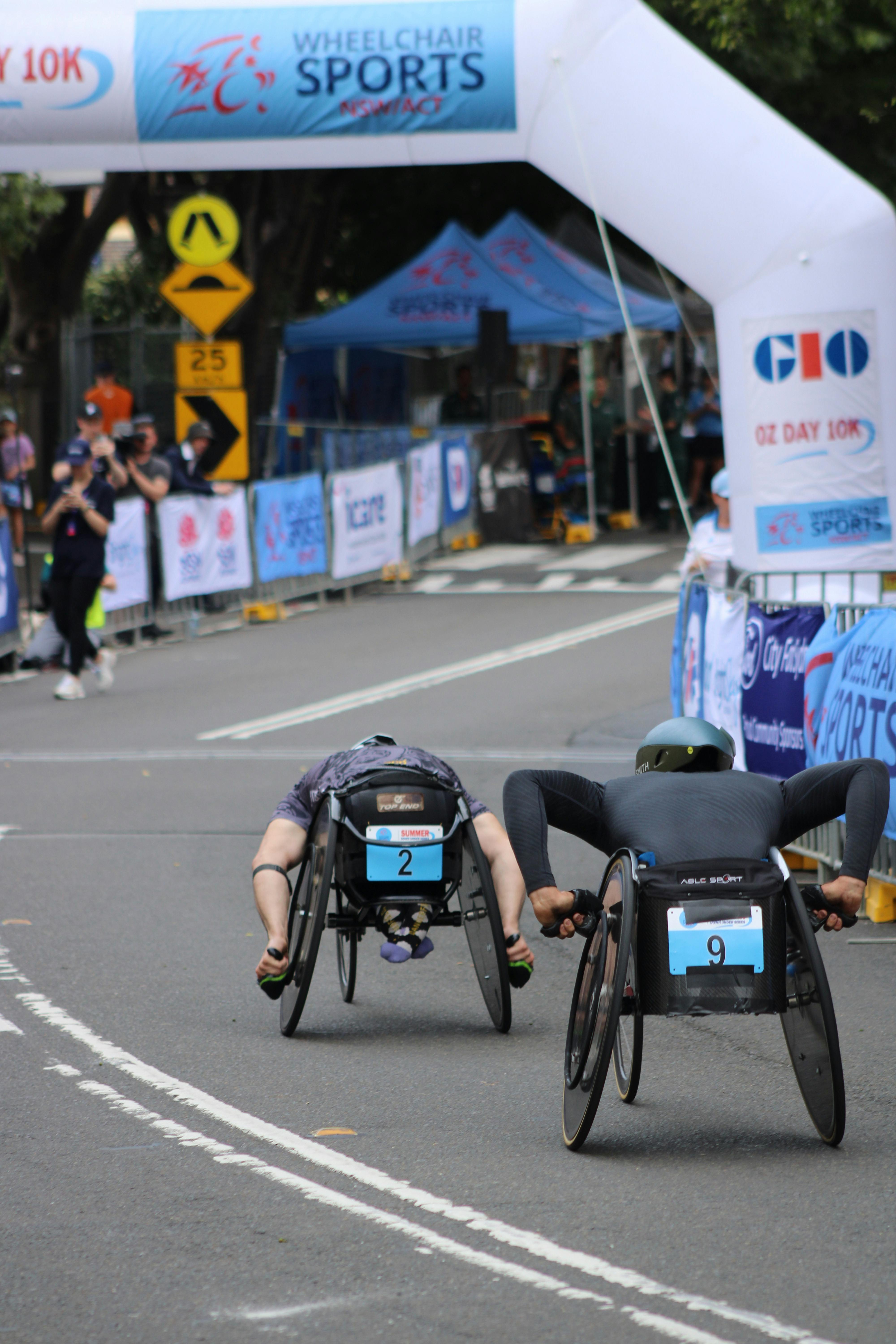 Wheelchair Athletes Racing Toward Finish Line · Free Stock Photo