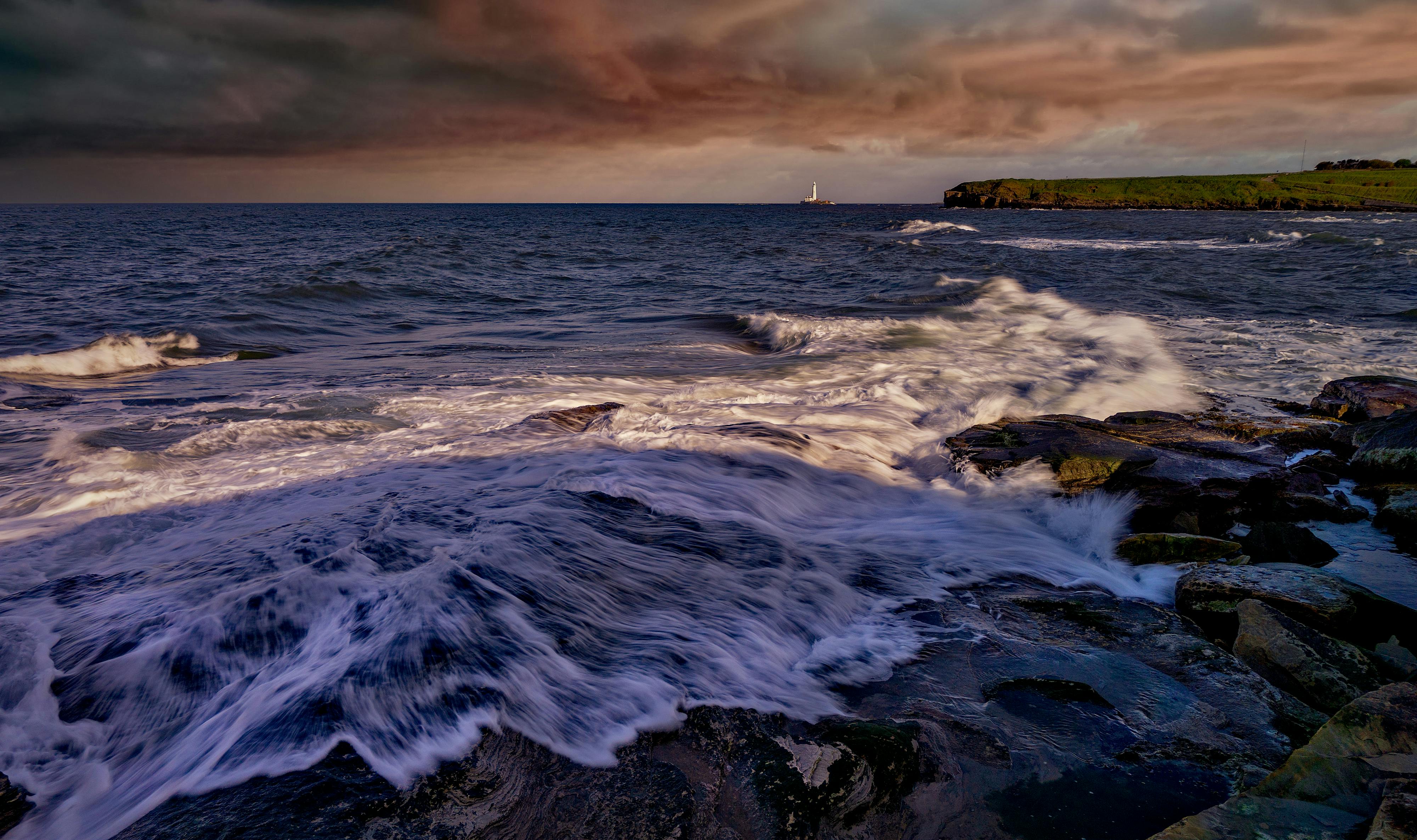 Dramatic Ocean Waves with Lighthouse at Dusk · Free Stock Photo