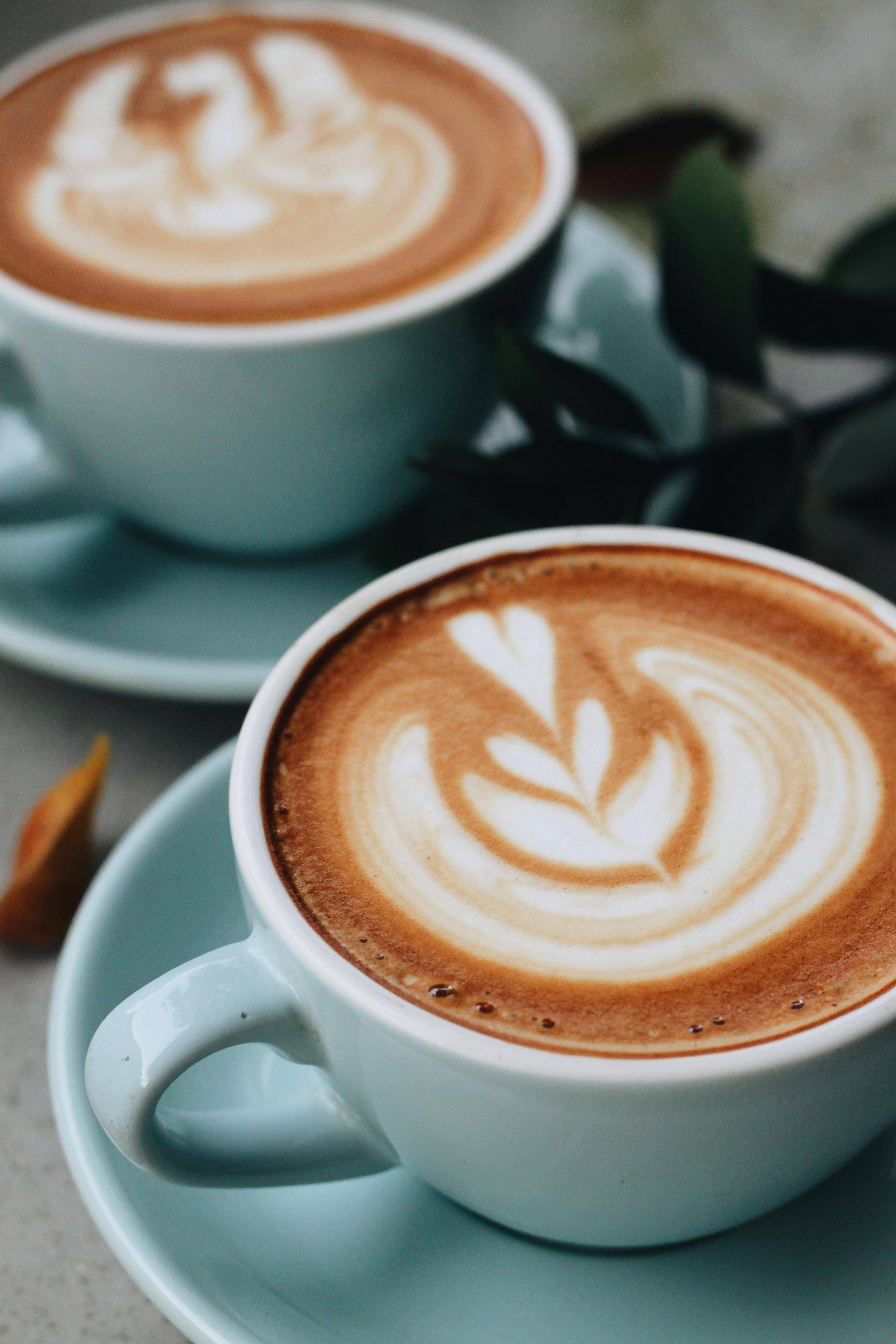 Elegant Blue Cup with Latte Art Foam Design · Free Stock Photo
