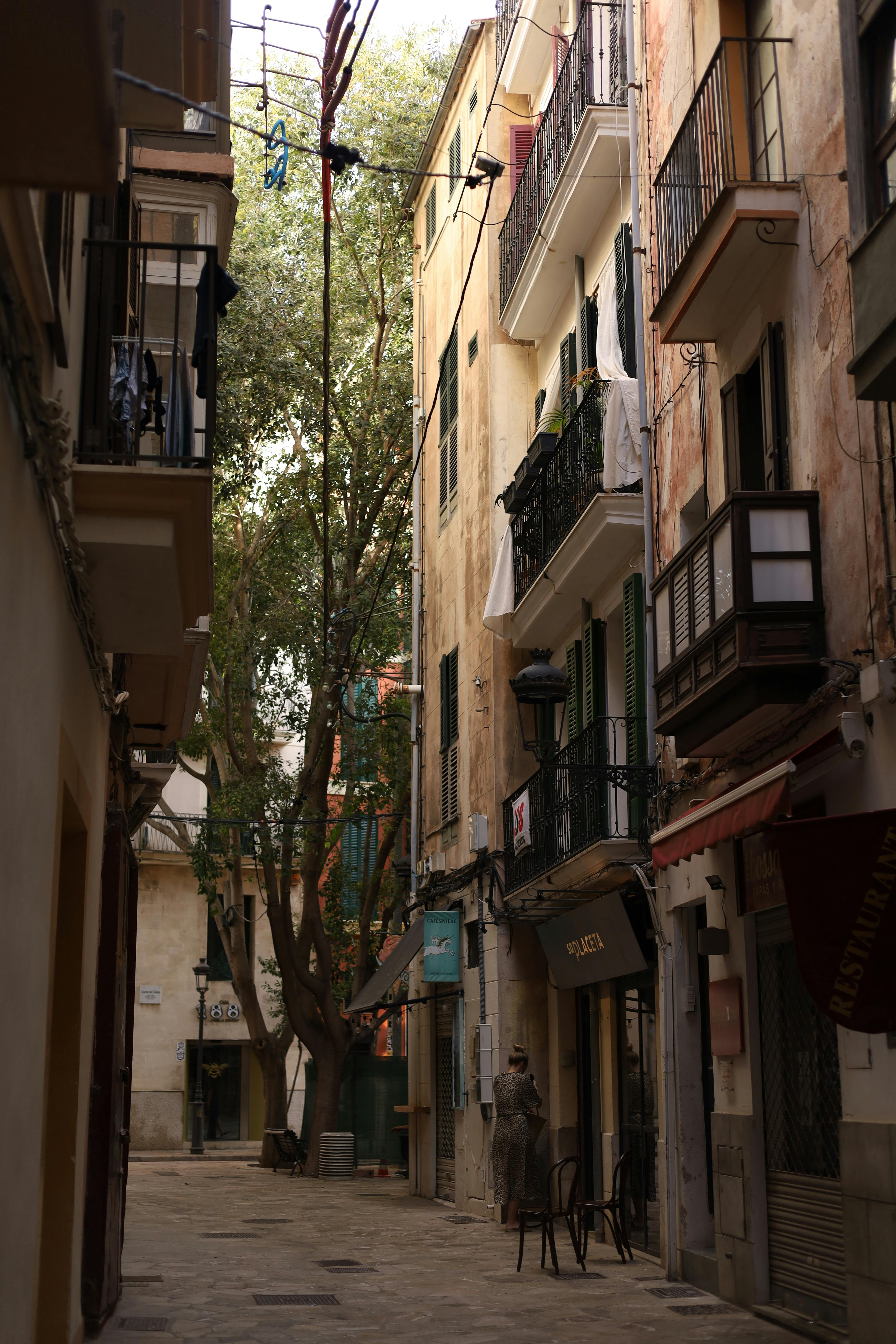 Charming European Alleyway with Rustic Buildings · Free Stock Photo