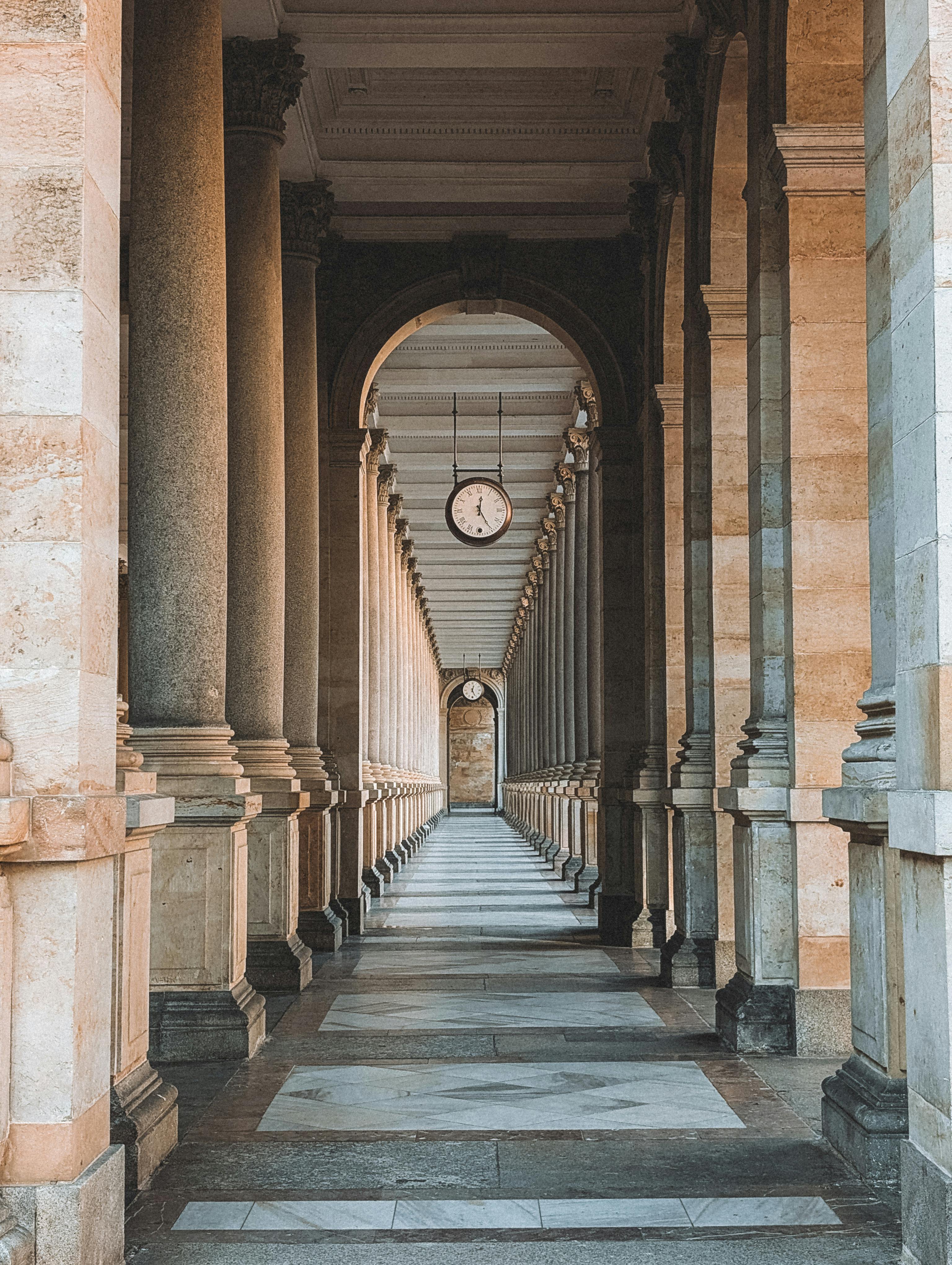 Symmetrical Architectural Colonnade with Clock · Free Stock Photo