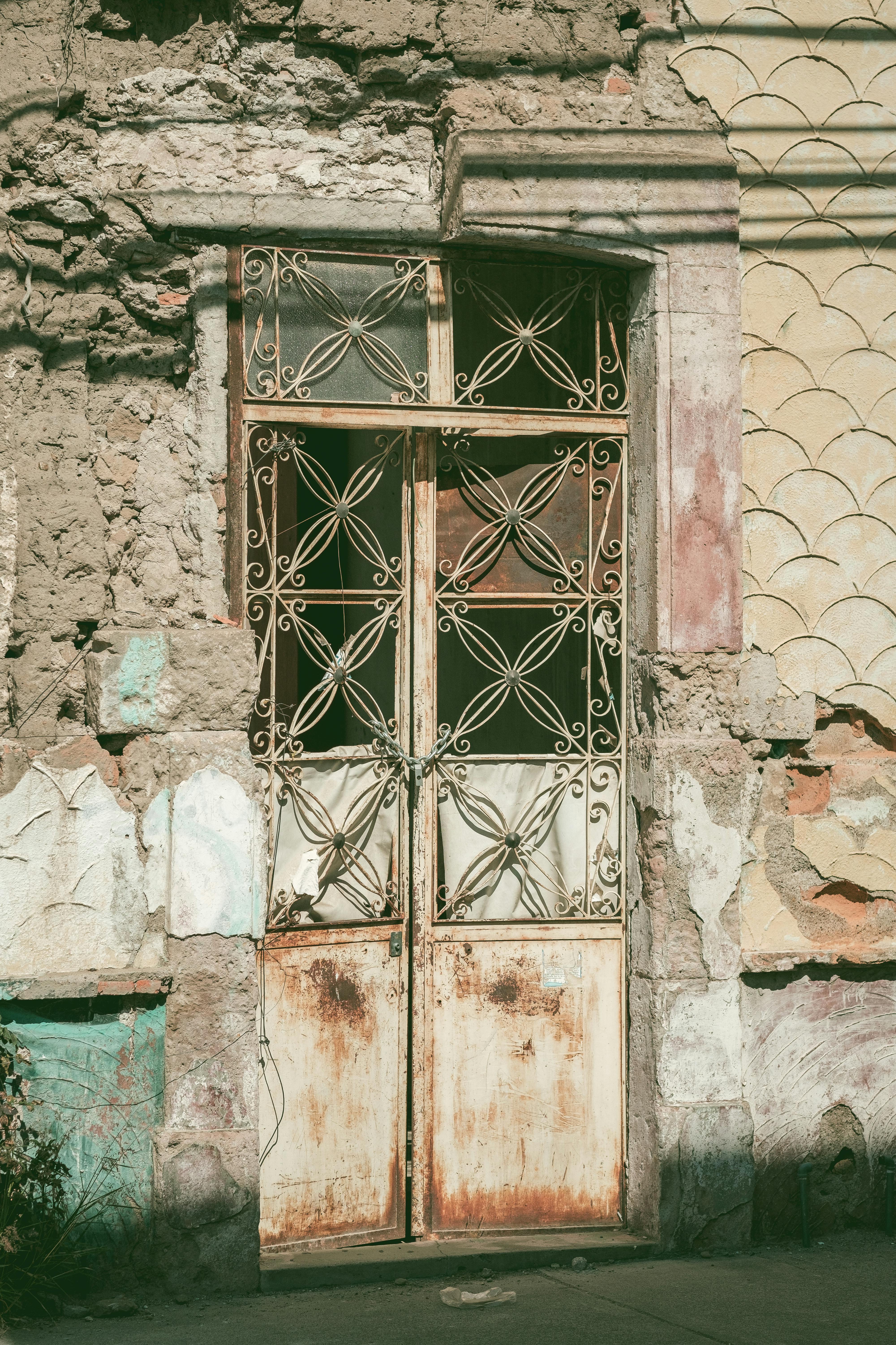 Rustic Metal Door on Weathered Stone Wall · Free Stock Photo