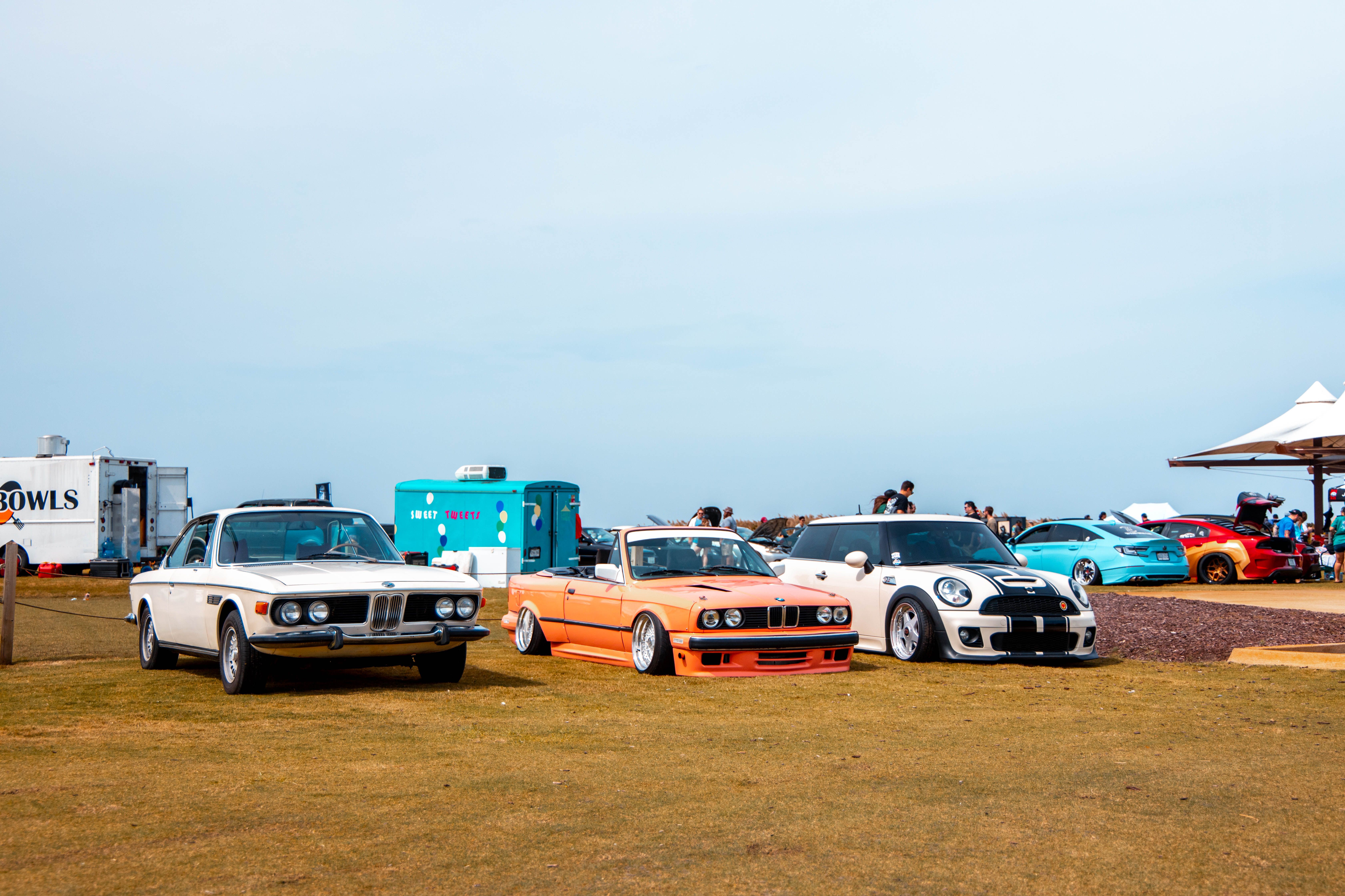 Vintage and Modern Cars Displayed Outdoors · Free Stock Photo