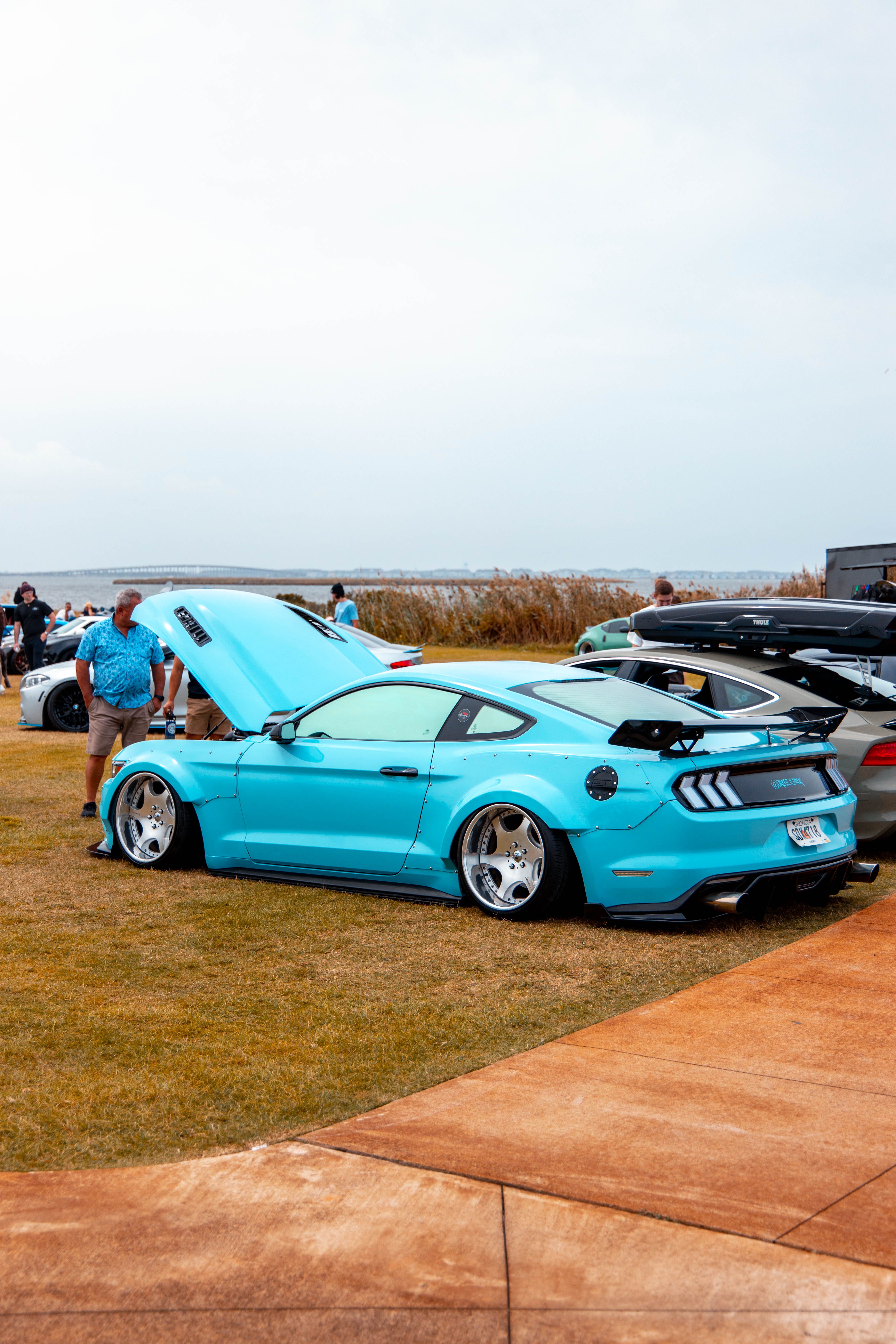 Vibrant Car Show with Modified Blue Sports Car · Free Stock Photo