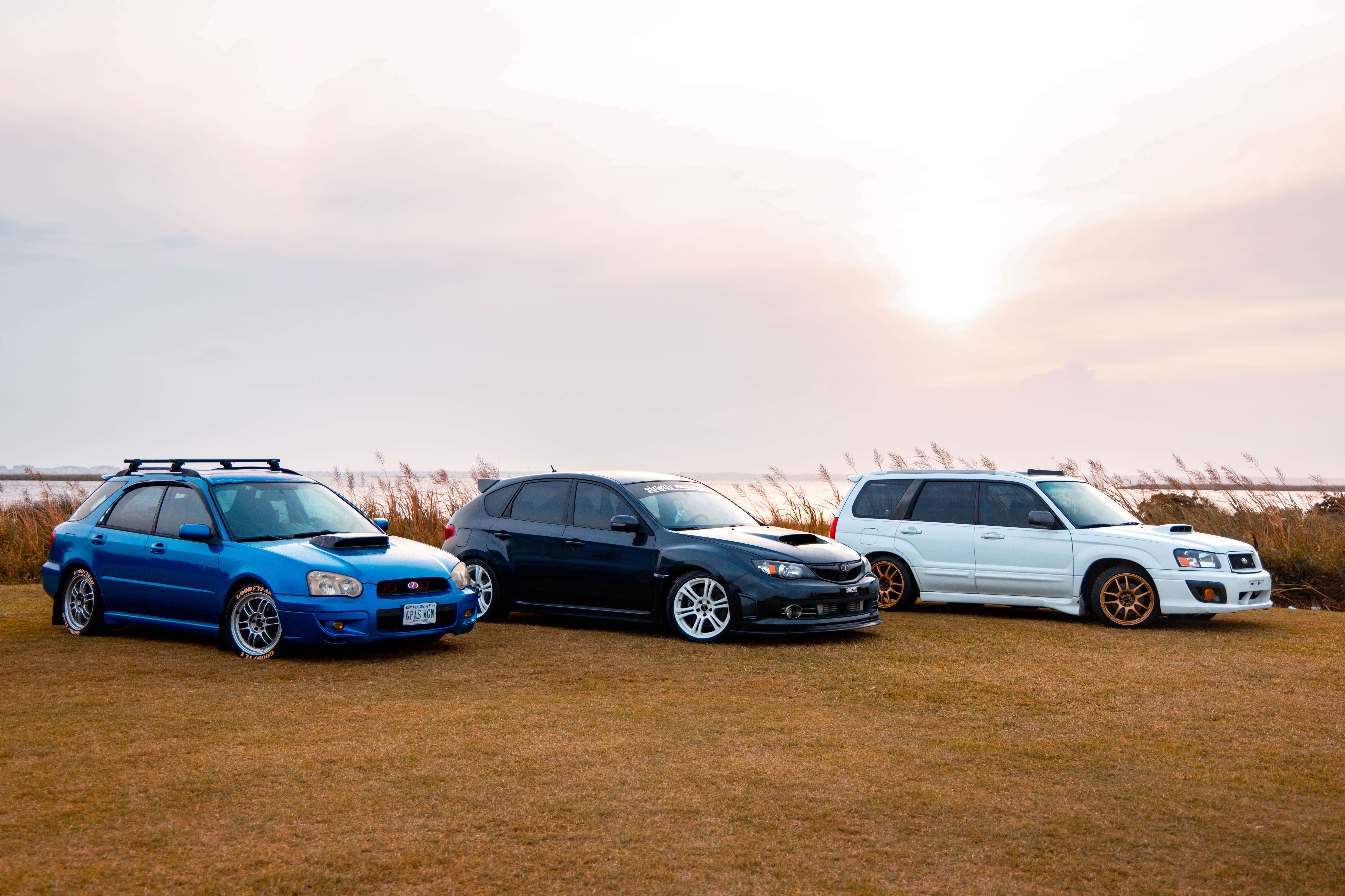 Trio of Subaru Cars in Scenic Outdoor Setting · Free Stock Photo
