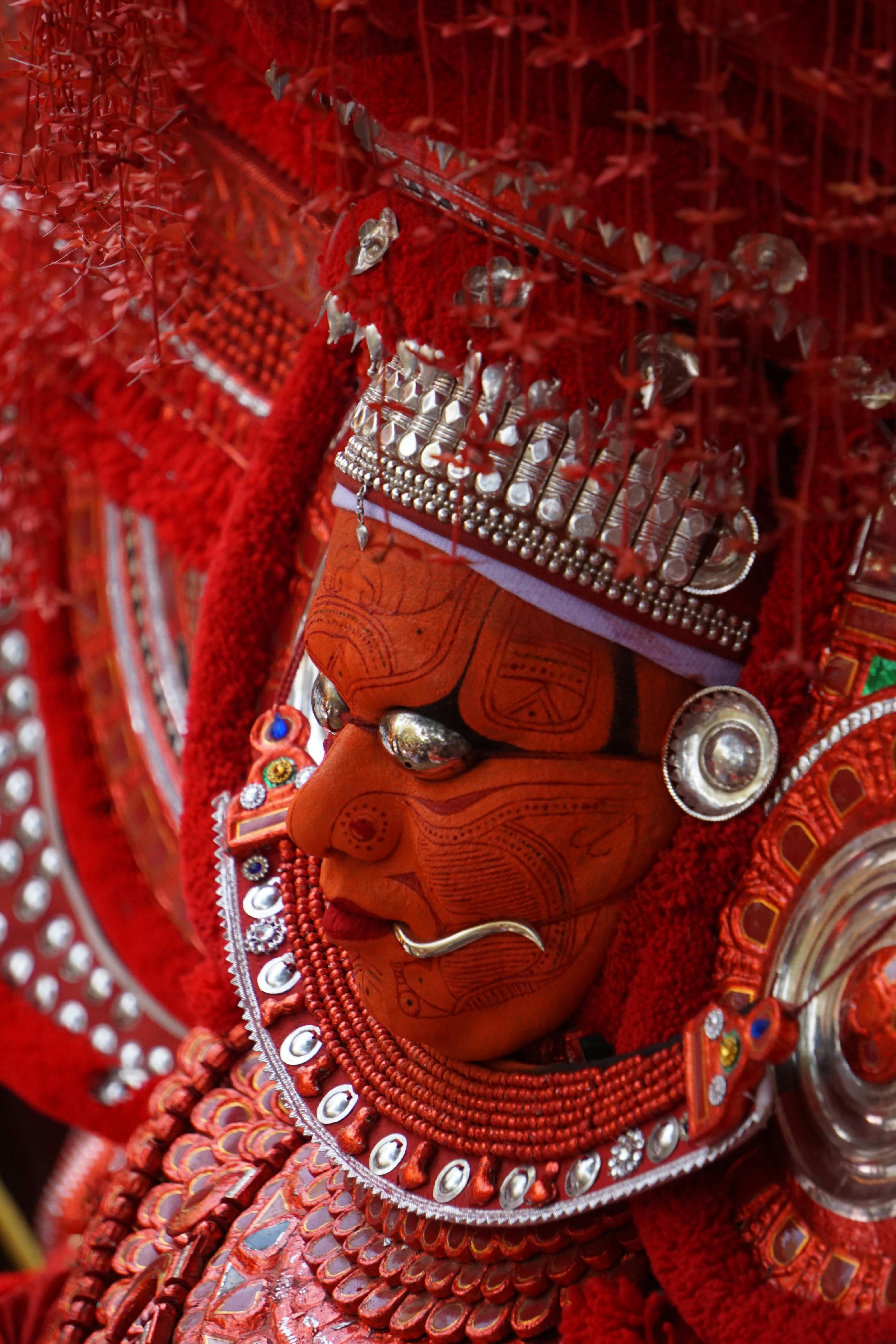Vibrant Theyyam Performer in Traditional Makeup · Free Stock Photo