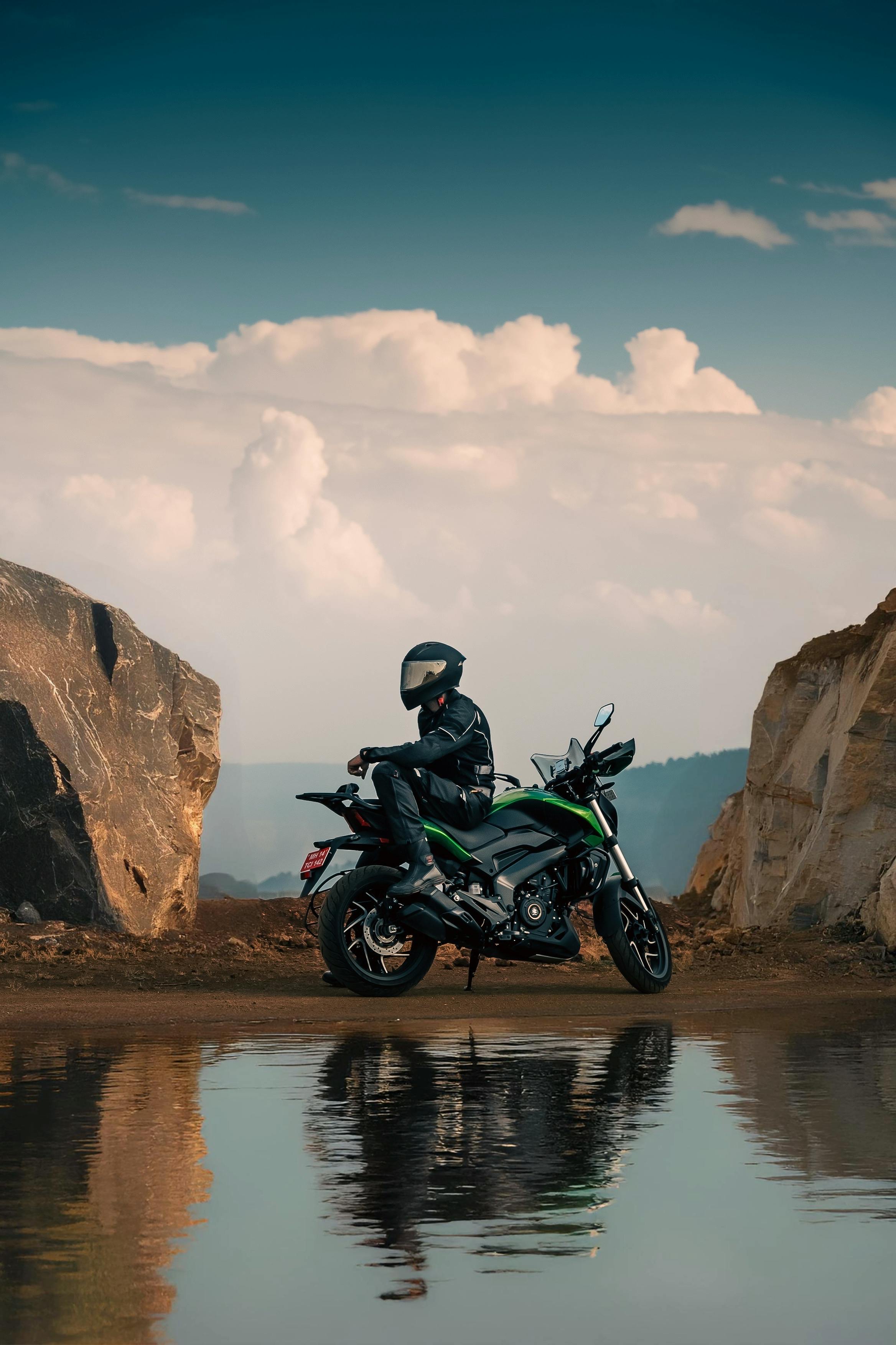 Biker on Mountain Motorcycle with Reflective Water View · Free Stock Photo