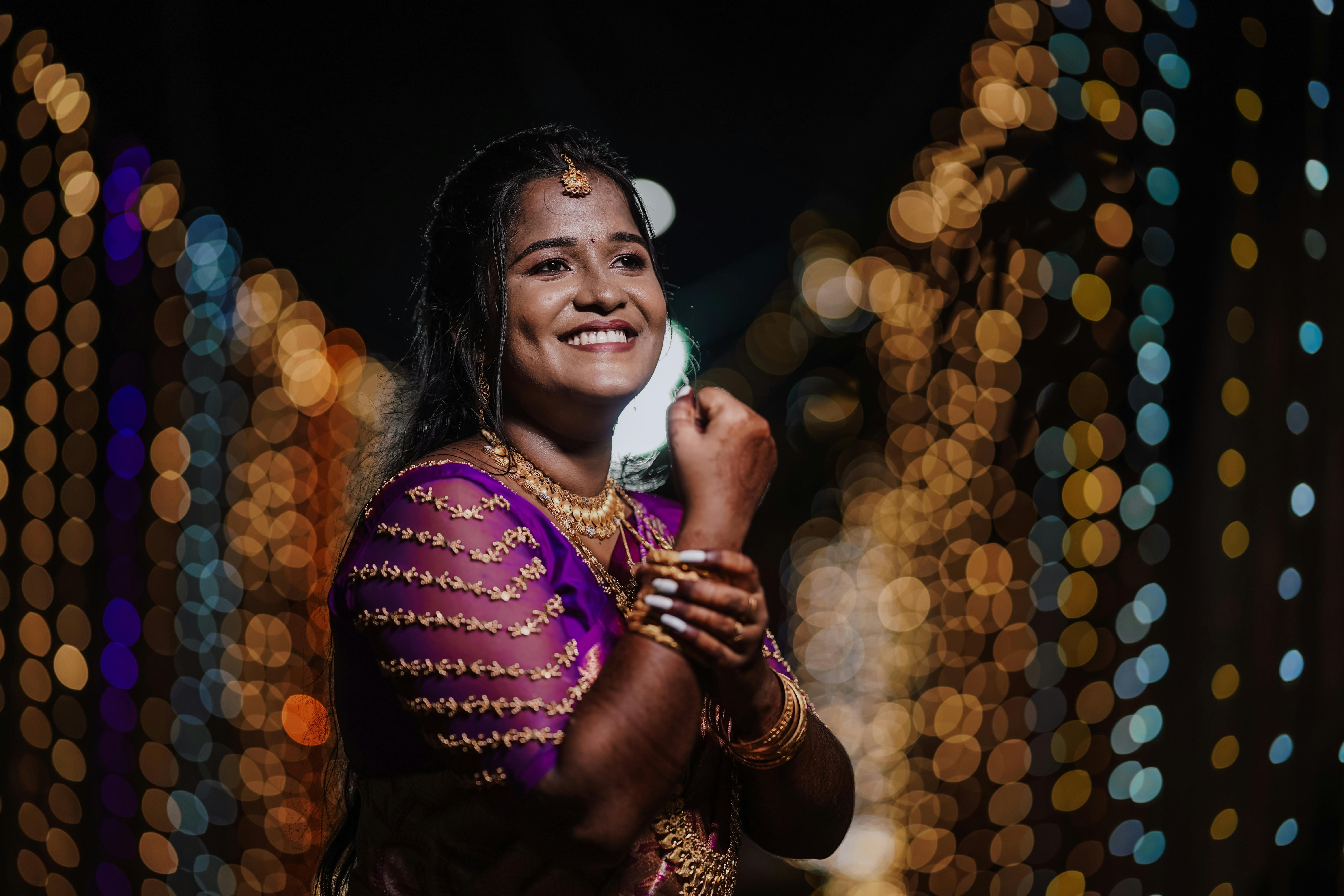 Elegant Bride in Traditional Saree with Bokeh Lights · Free Stock Photo