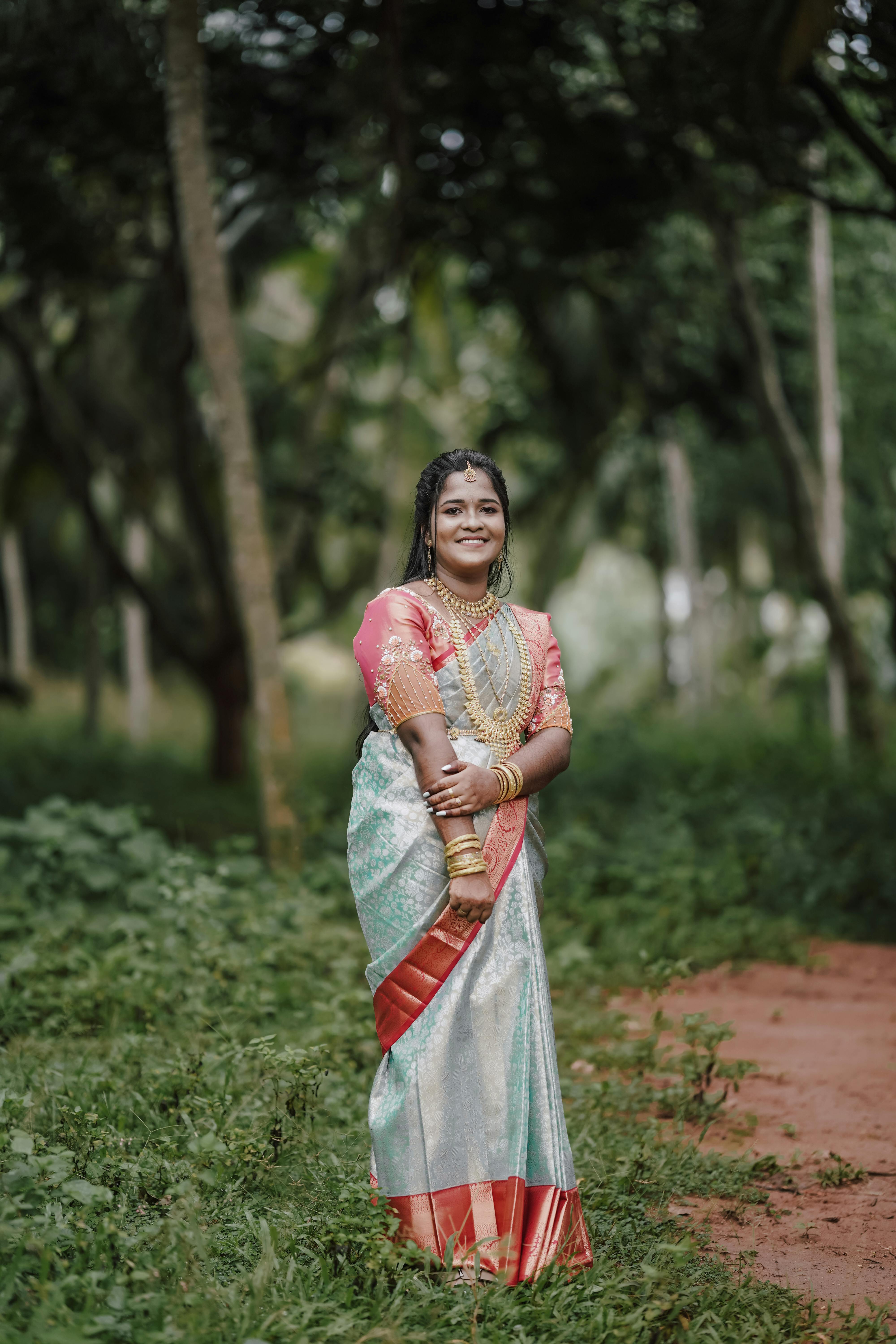 Traditional Indian Bride in Lush Greenery · Free Stock Photo